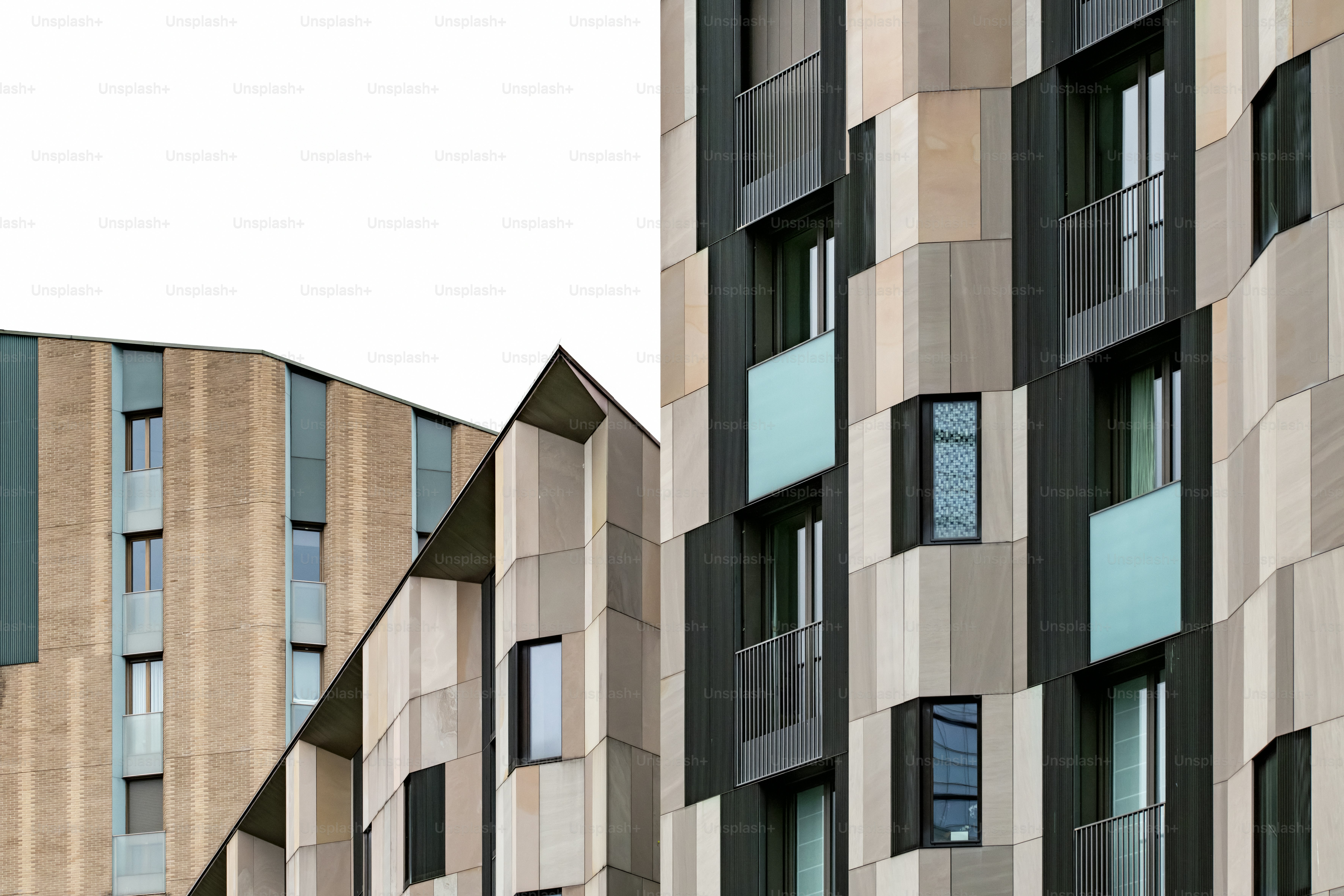 A couple of tall buildings with windows next to each other photo ...