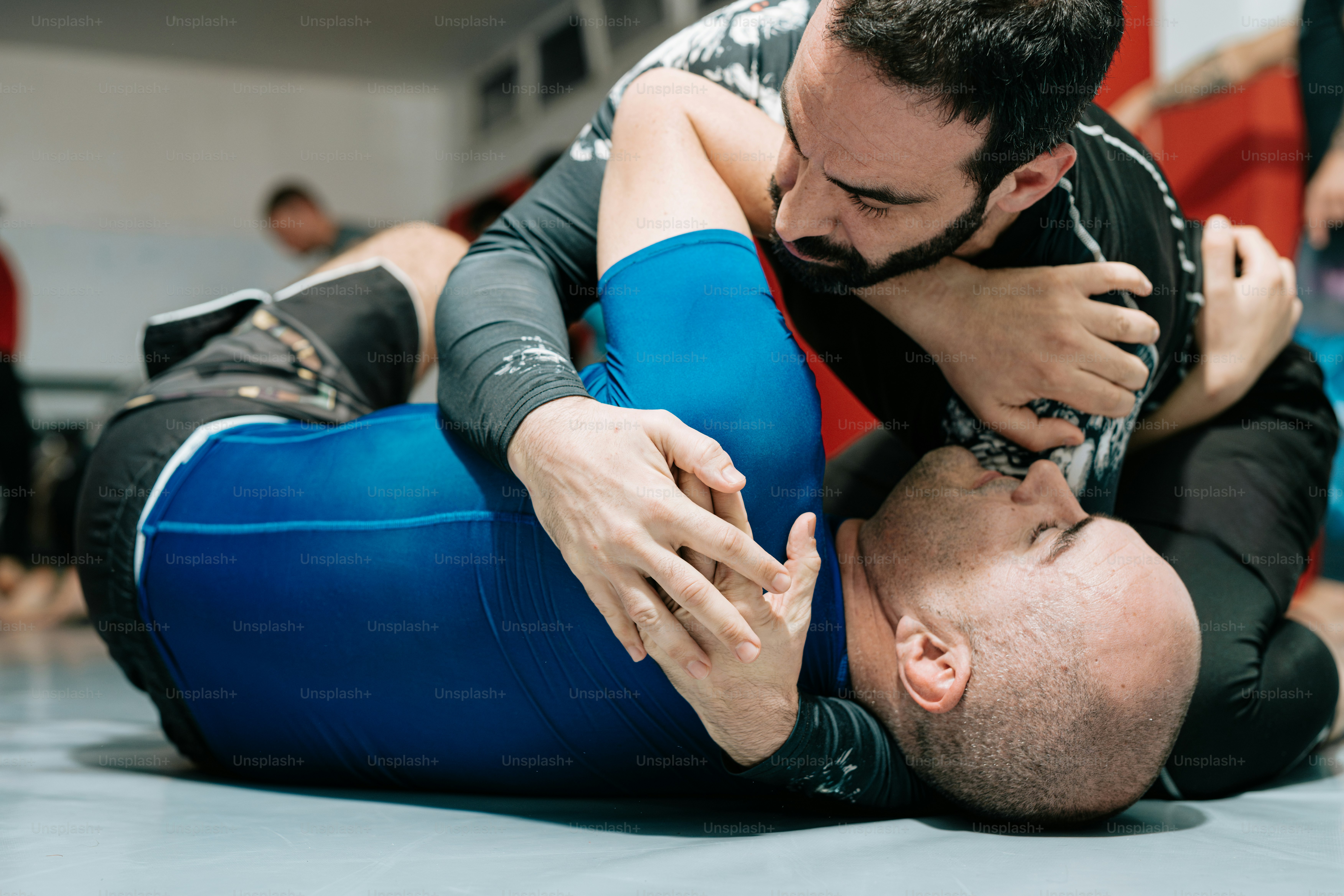 A man wrestling another man in a wrestling ring photo – Training Image ...