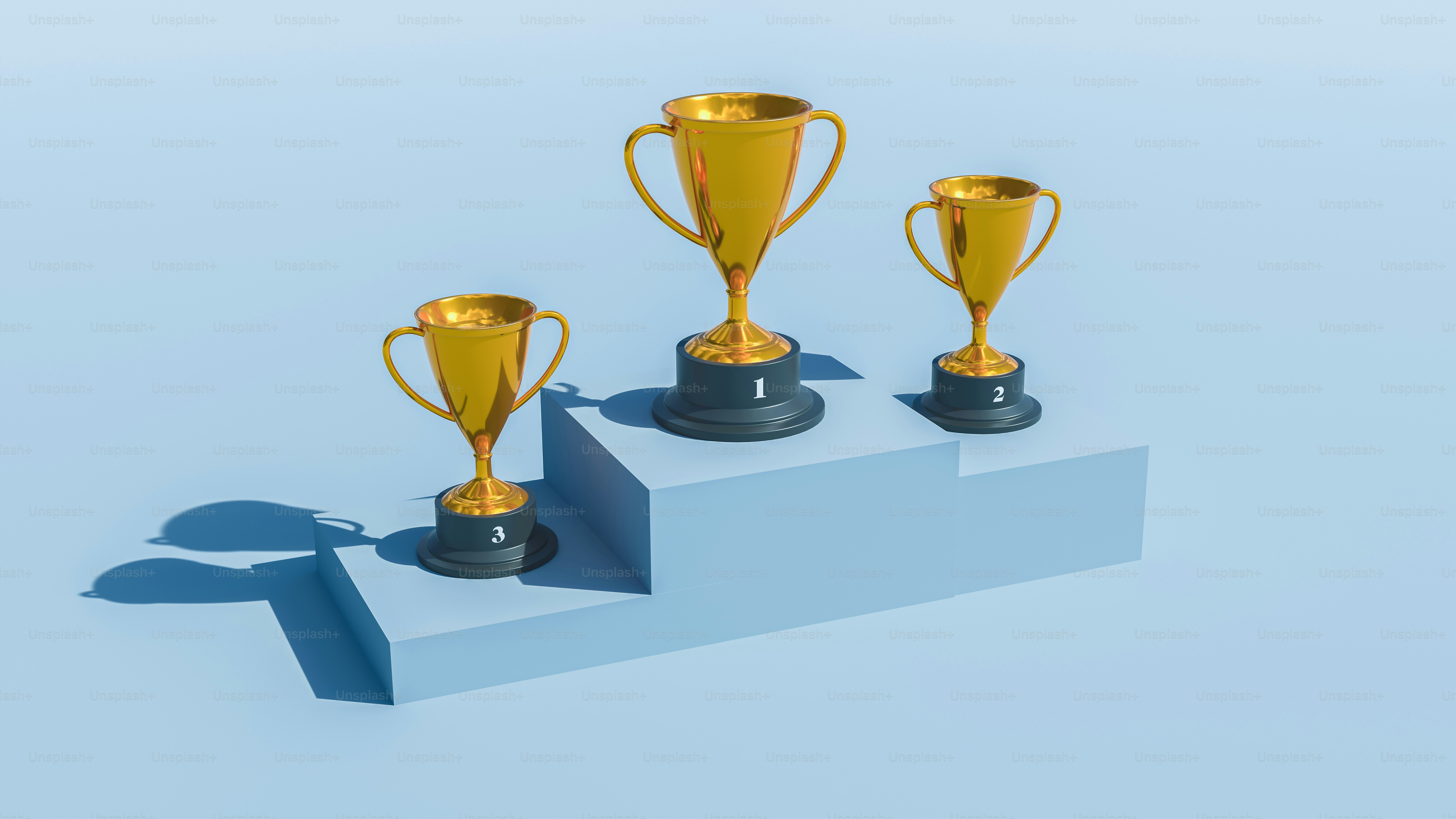 Three golden trophies sitting on top of a blue pedestal photo – Trophy ...