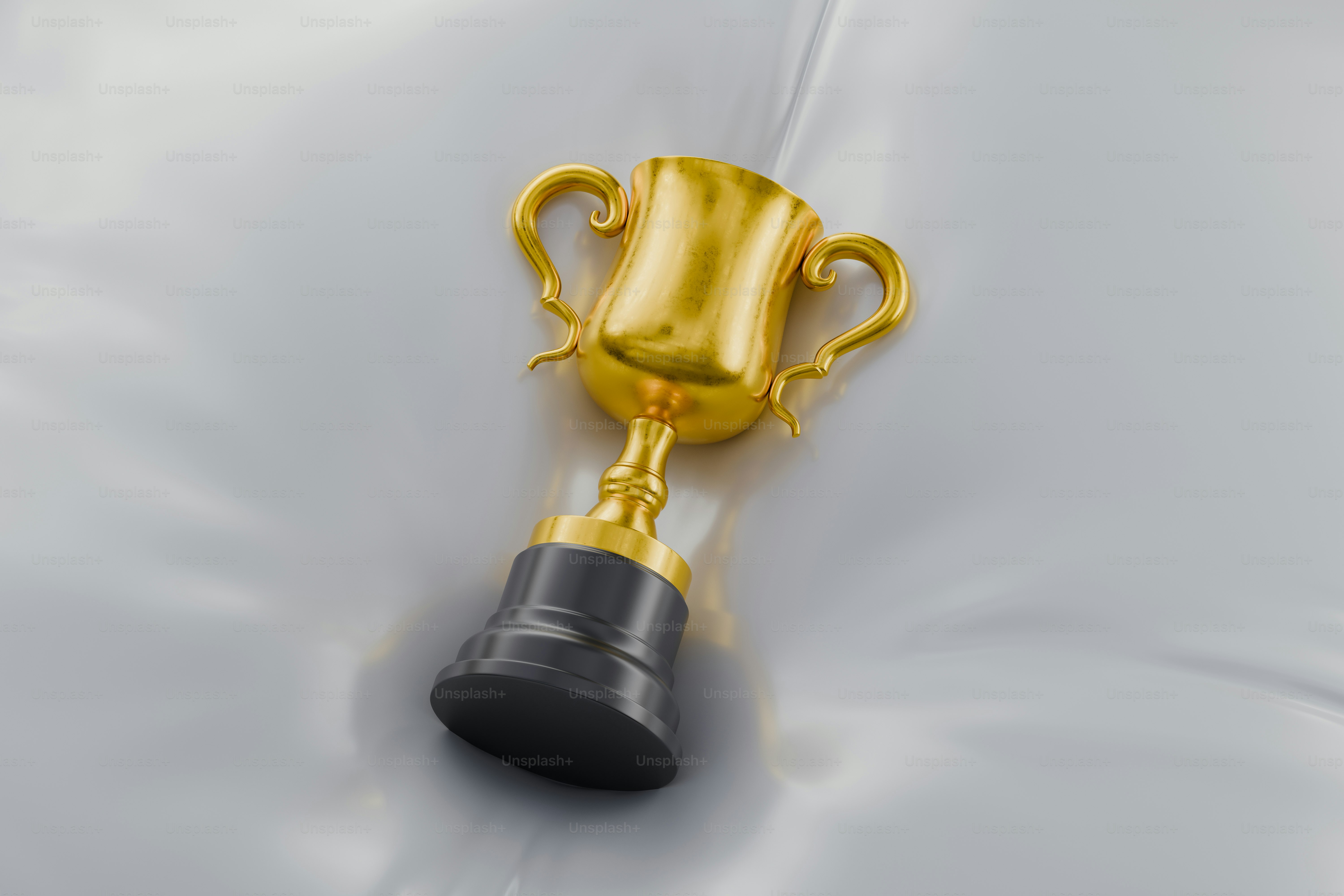 A golden trophy with a black base on a white background photo – Golden ...