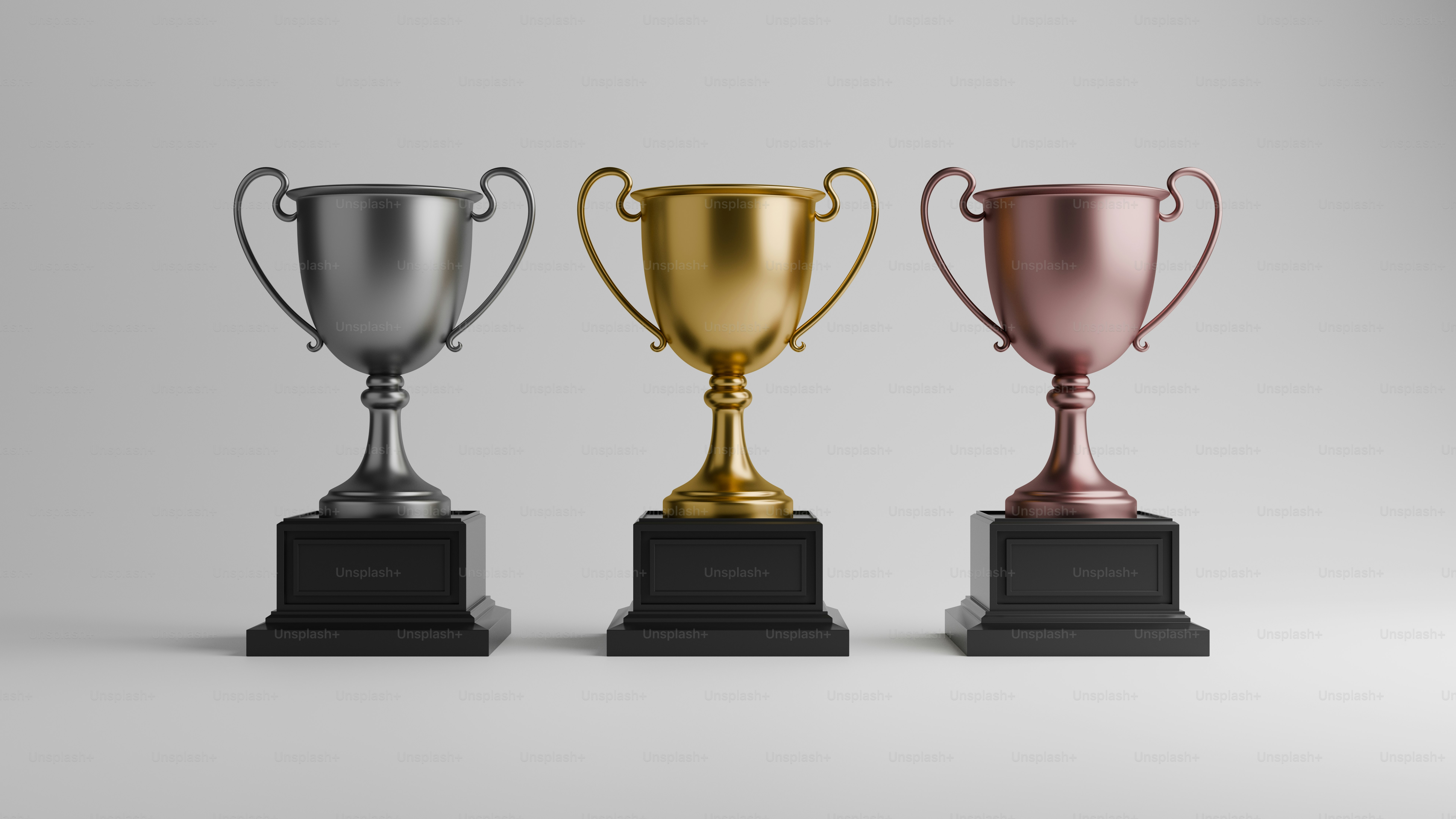 A row of three trophies sitting on top of each other photo – Winner ...