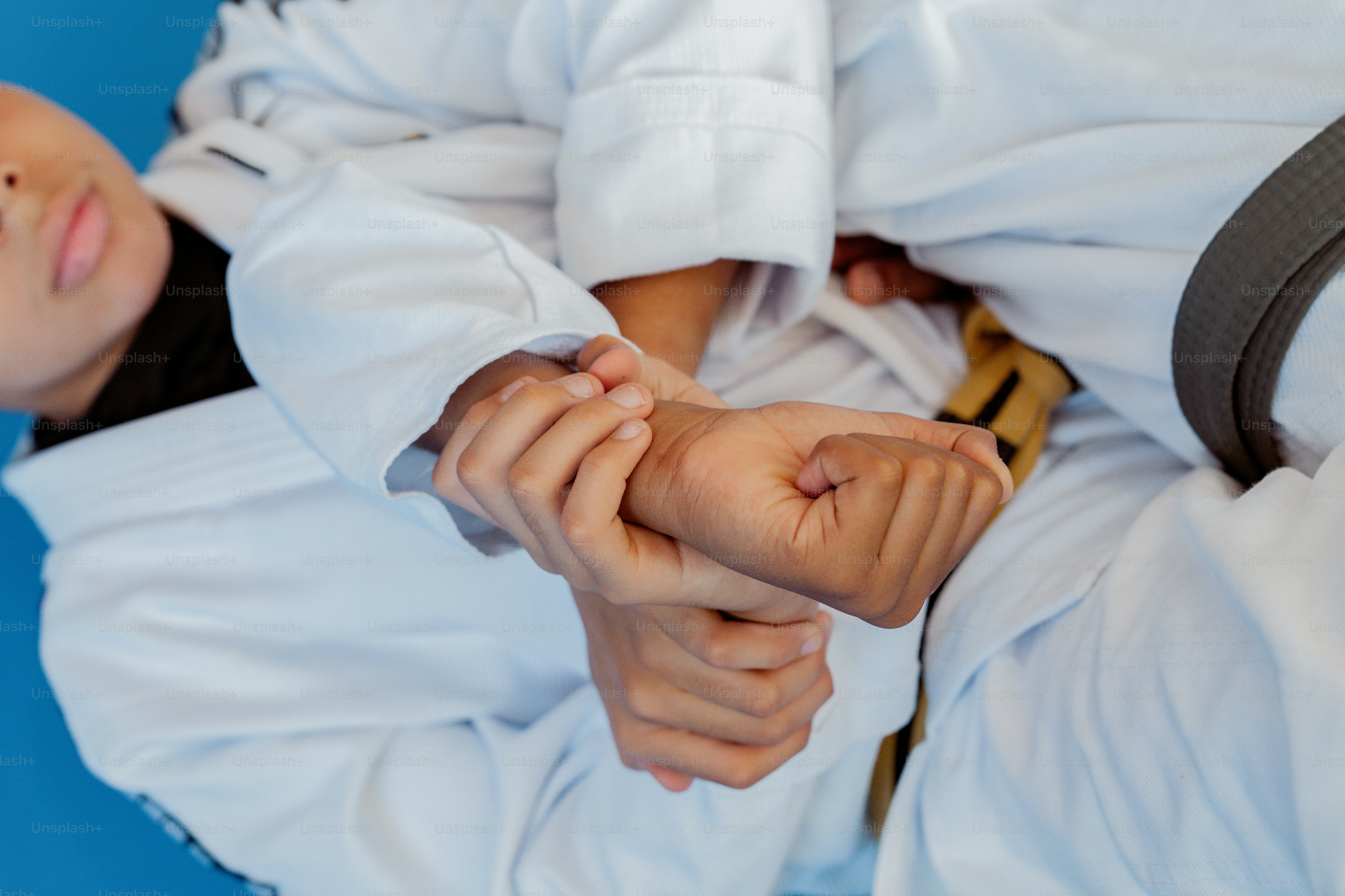 A young boy is holding his hands together photo – Jiu jitsu Image on ...