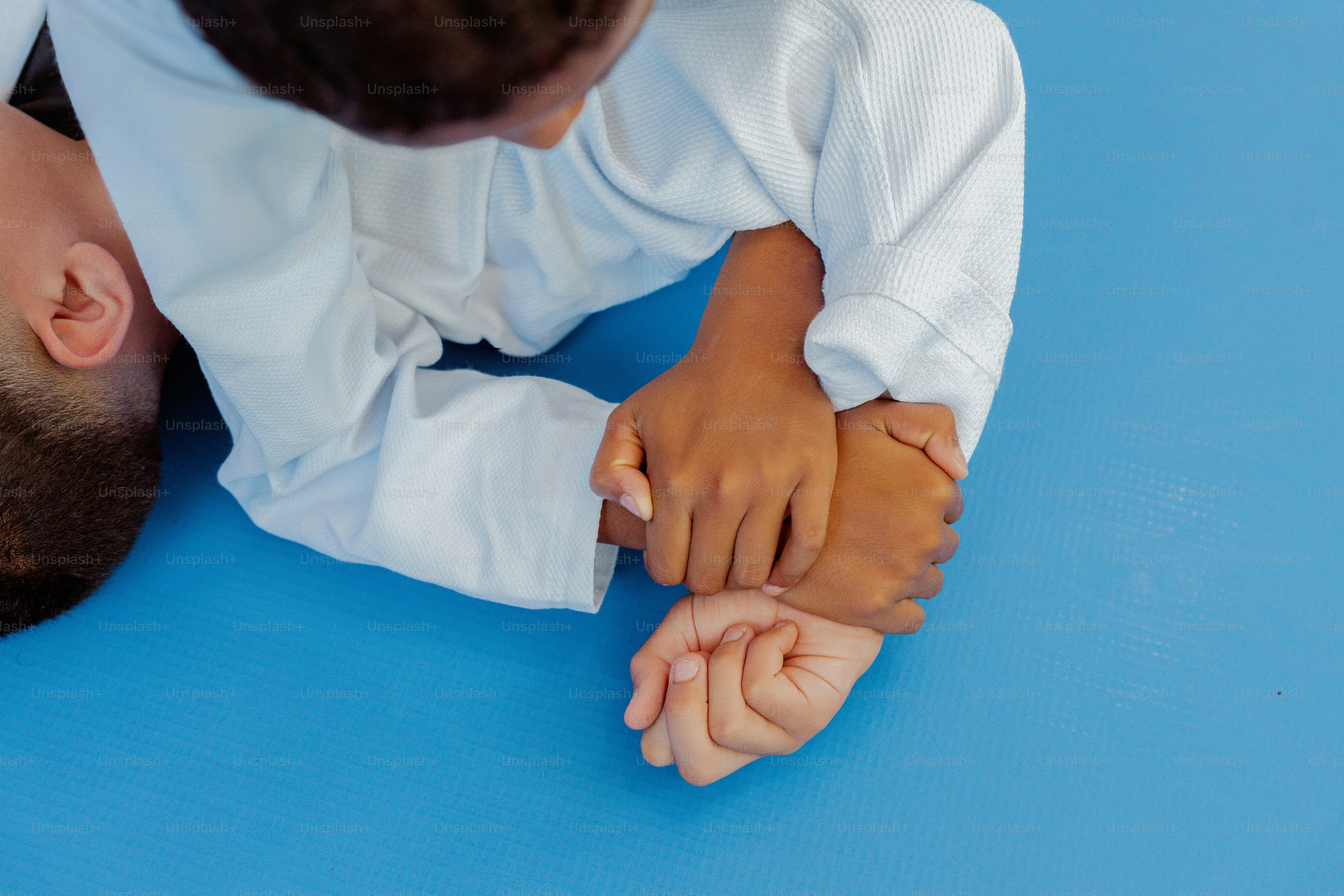 A young child is holding the hand of an adult photo – Jiu jitsu Image ...