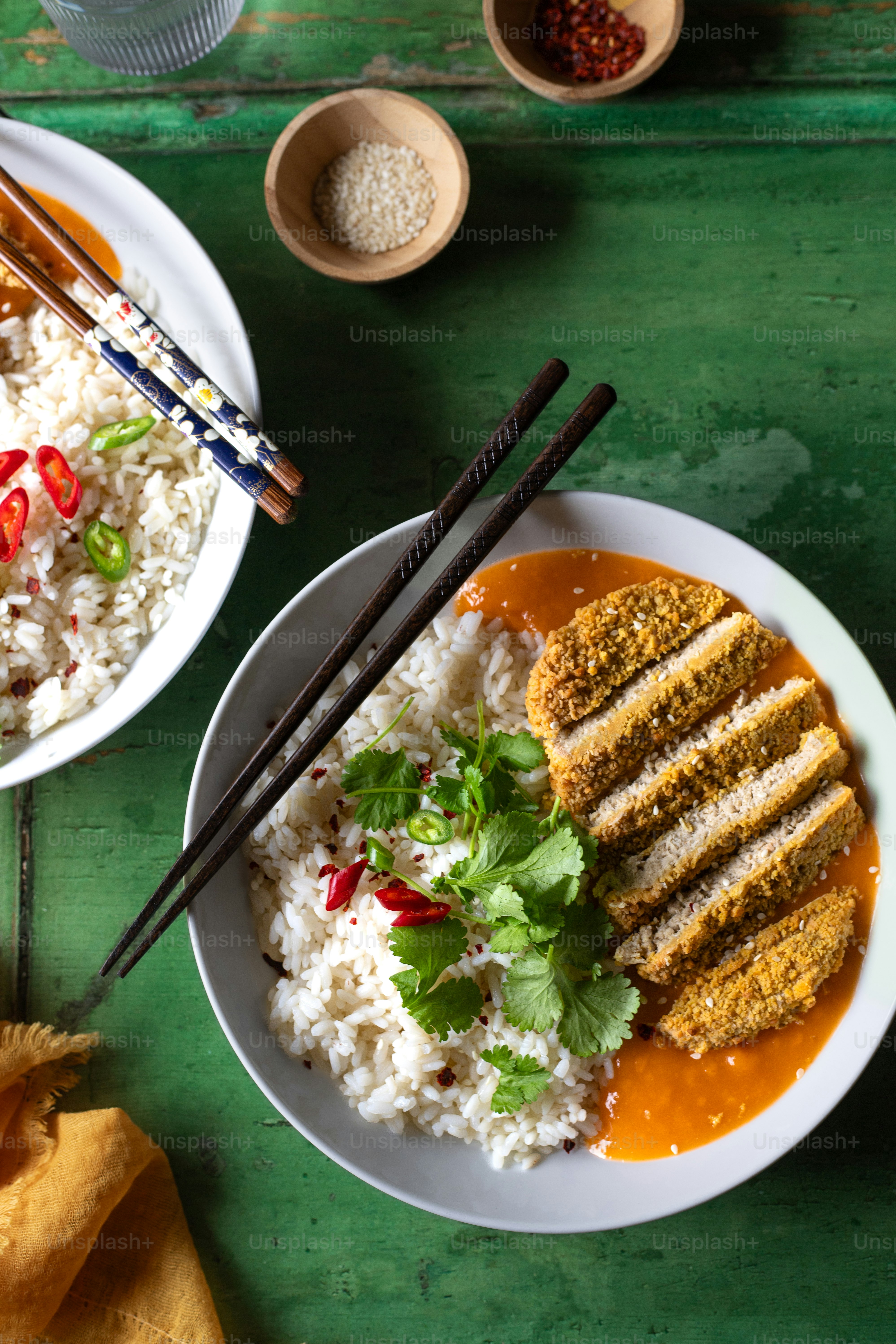 Two plates of food with chopsticks and rice photo – Vegan dish Image on ...