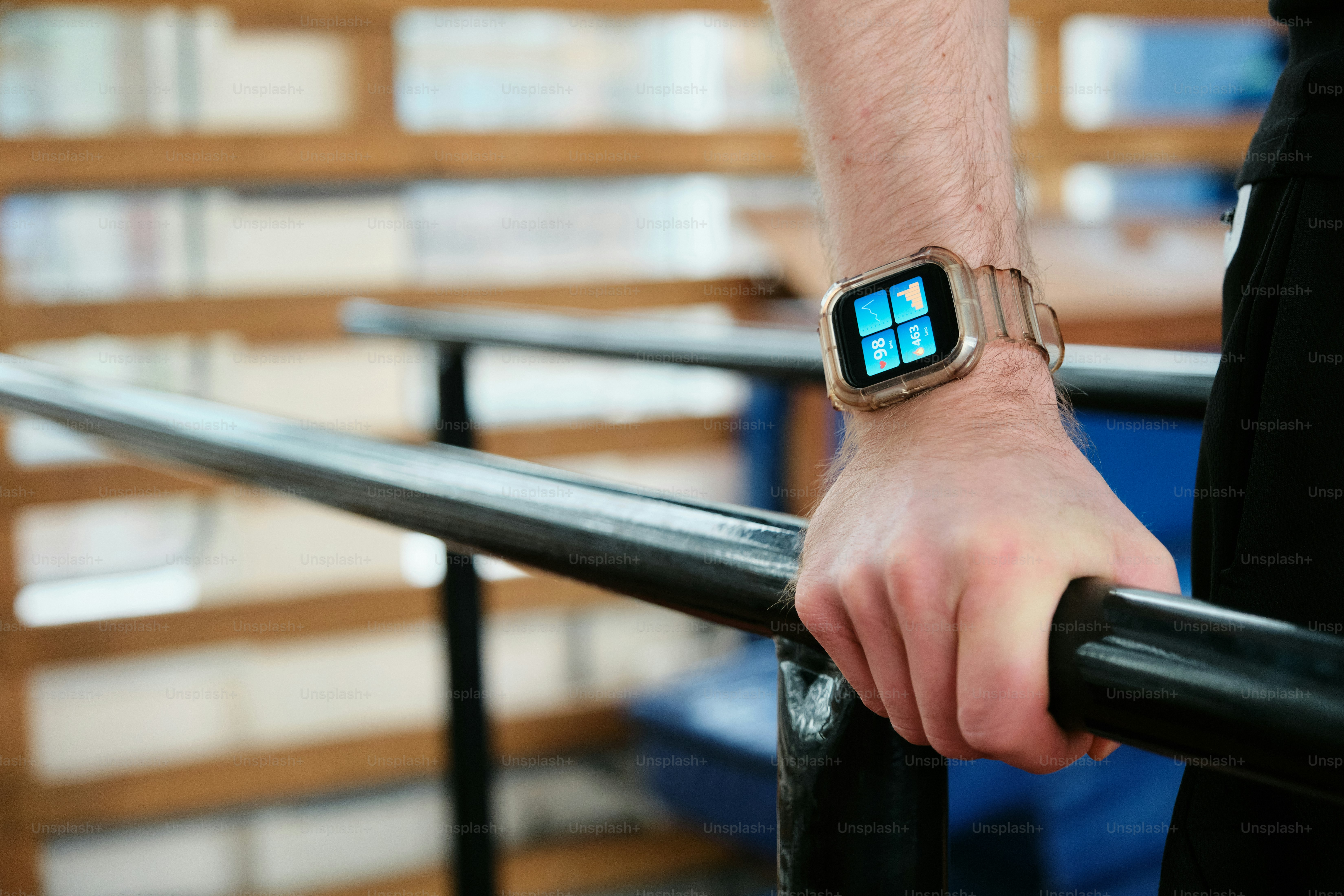 A close up of a person holding onto a railing photo – Wearable tech ...