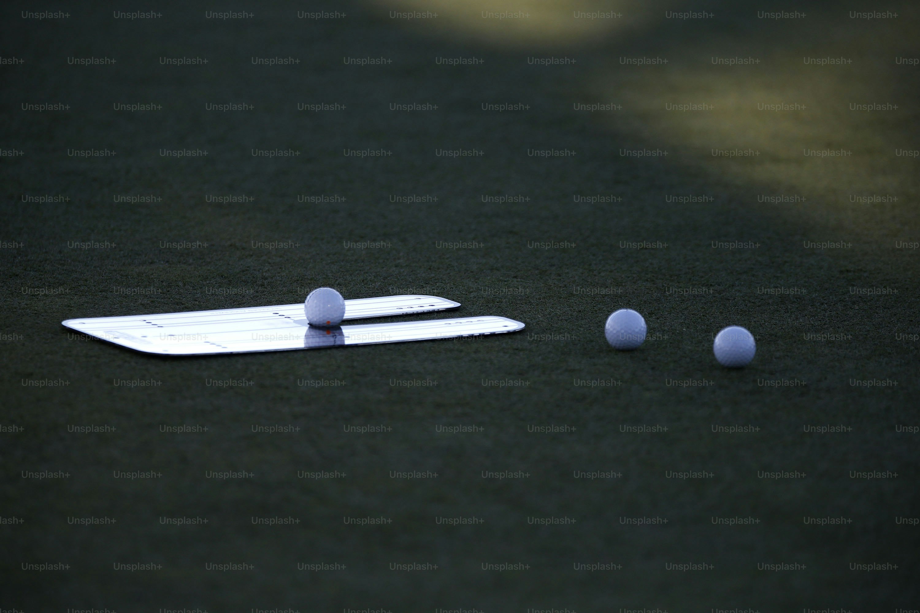 A pair of white paddles laying on top of a green field photo – Golf ...