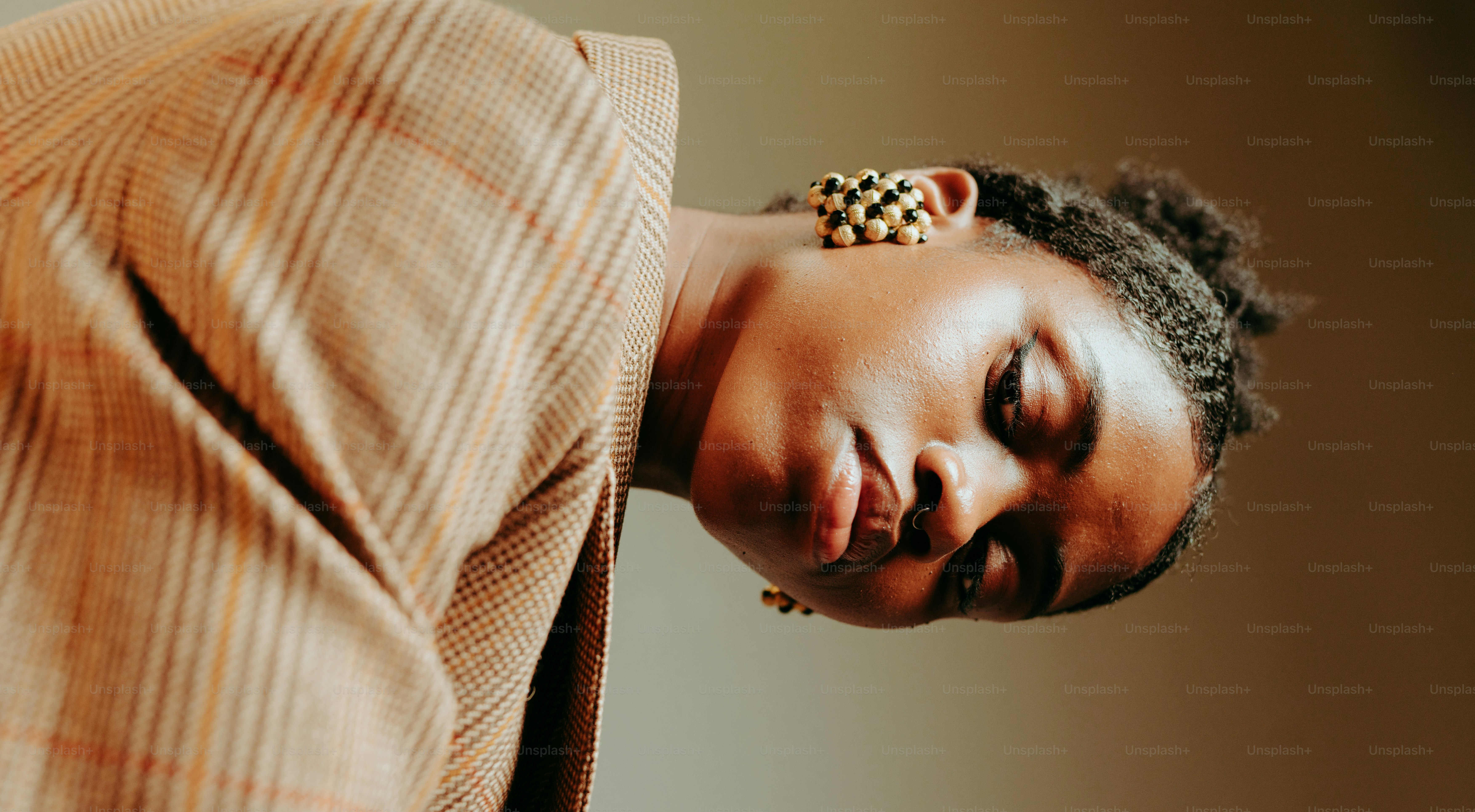 A woman with her eyes closed and her hair in a bun photo – Attitude ...