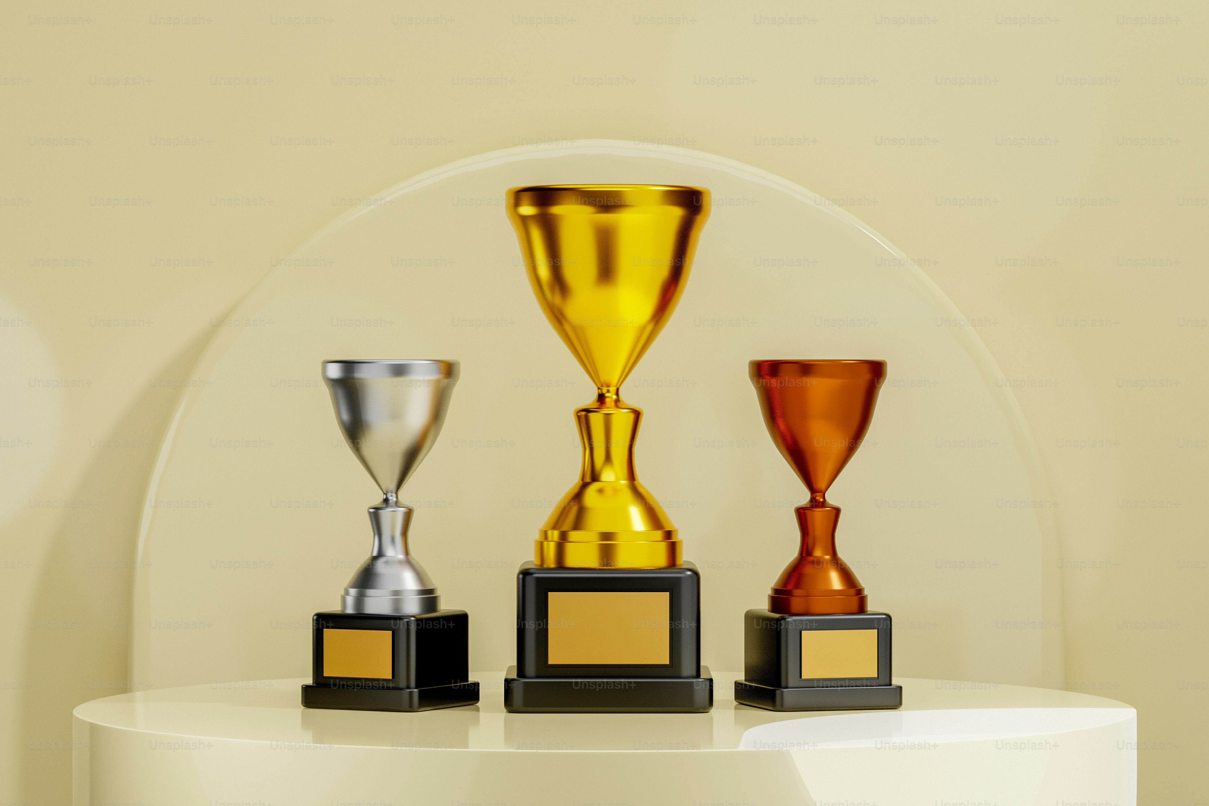 A group of trophies sitting on top of a white table photo – Trophy ...