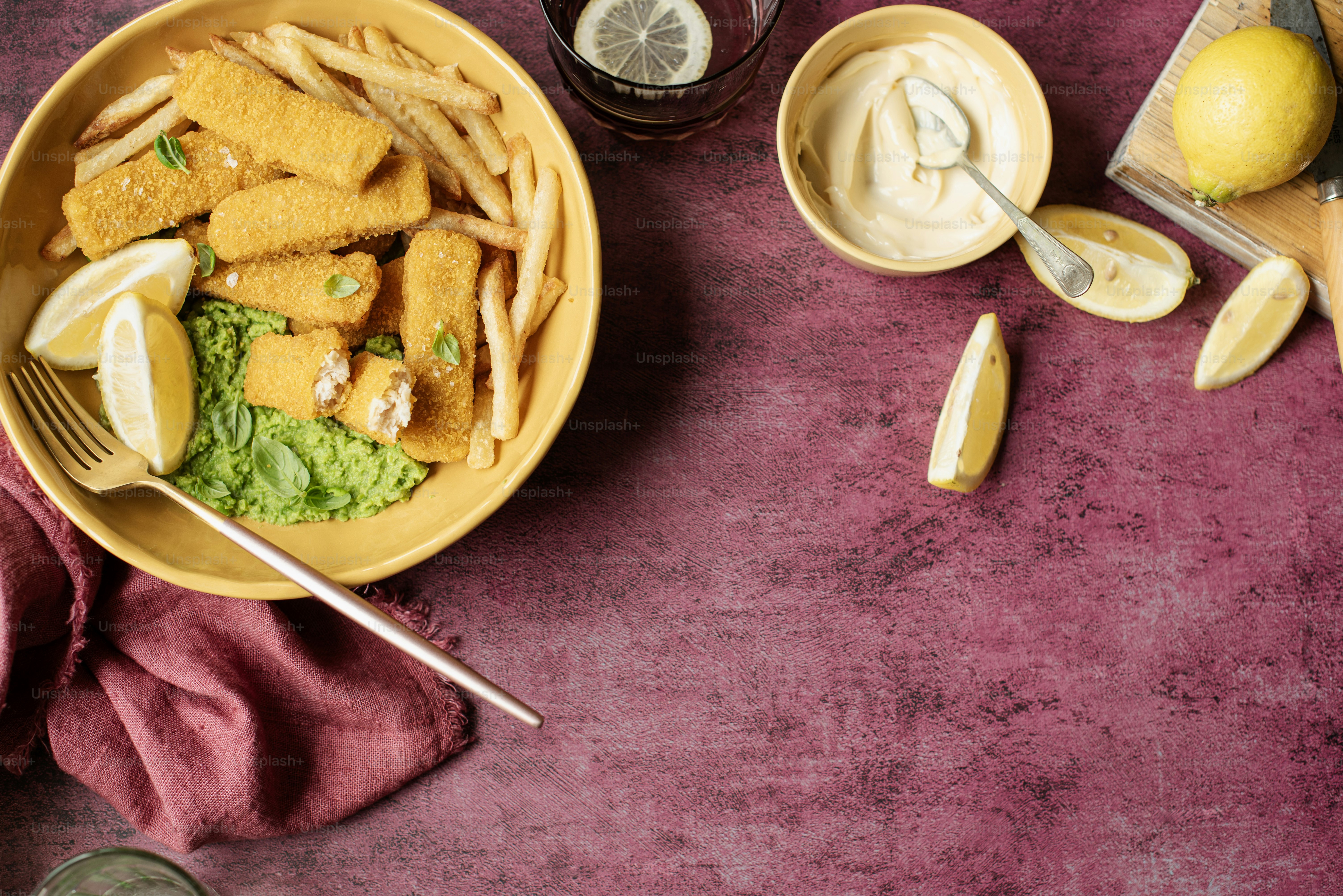 A bowl of fish and chips next to a glass of beer photo – Vegan food ...