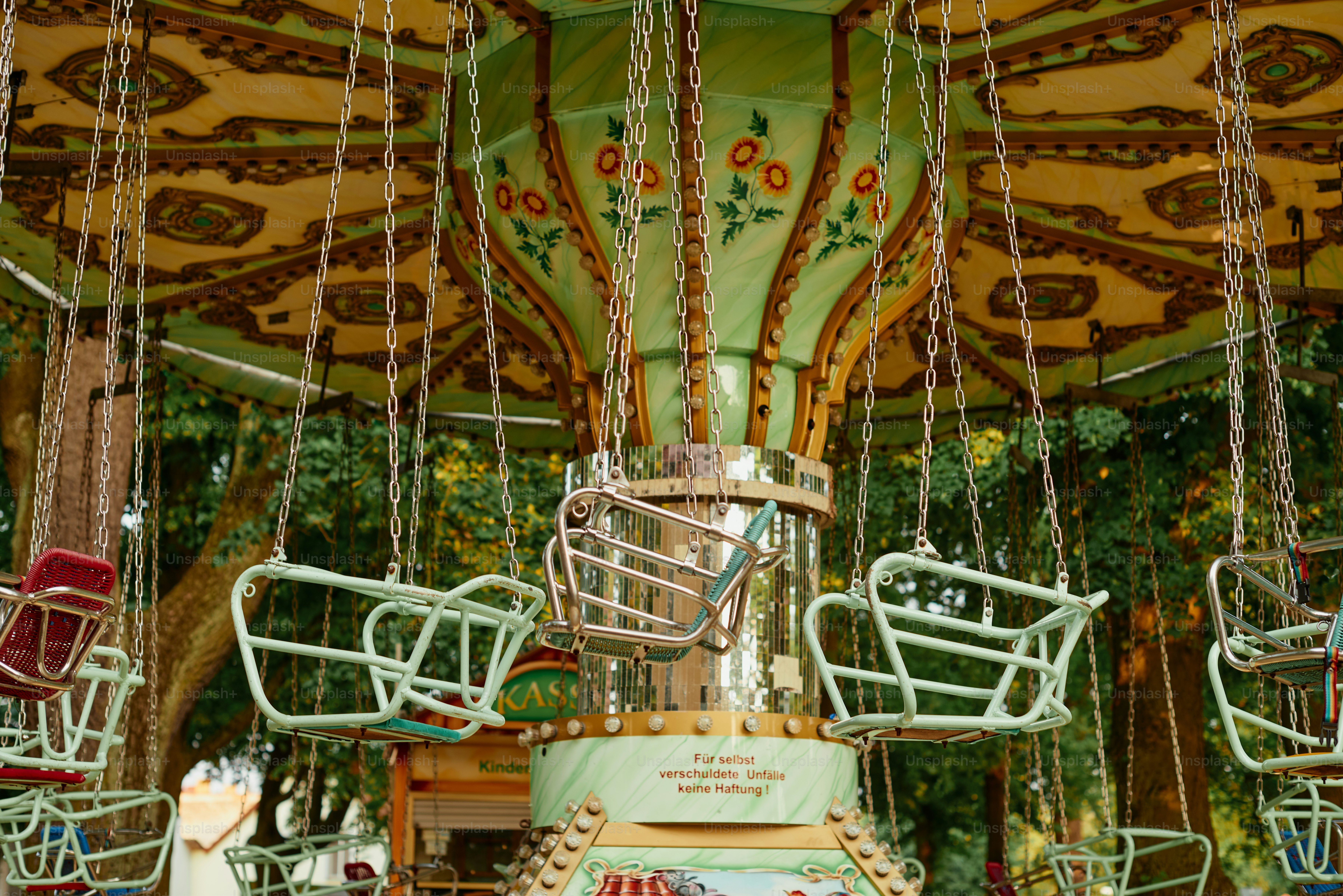 A merry go round ride with lots of swings photo – Amusement park Image ...