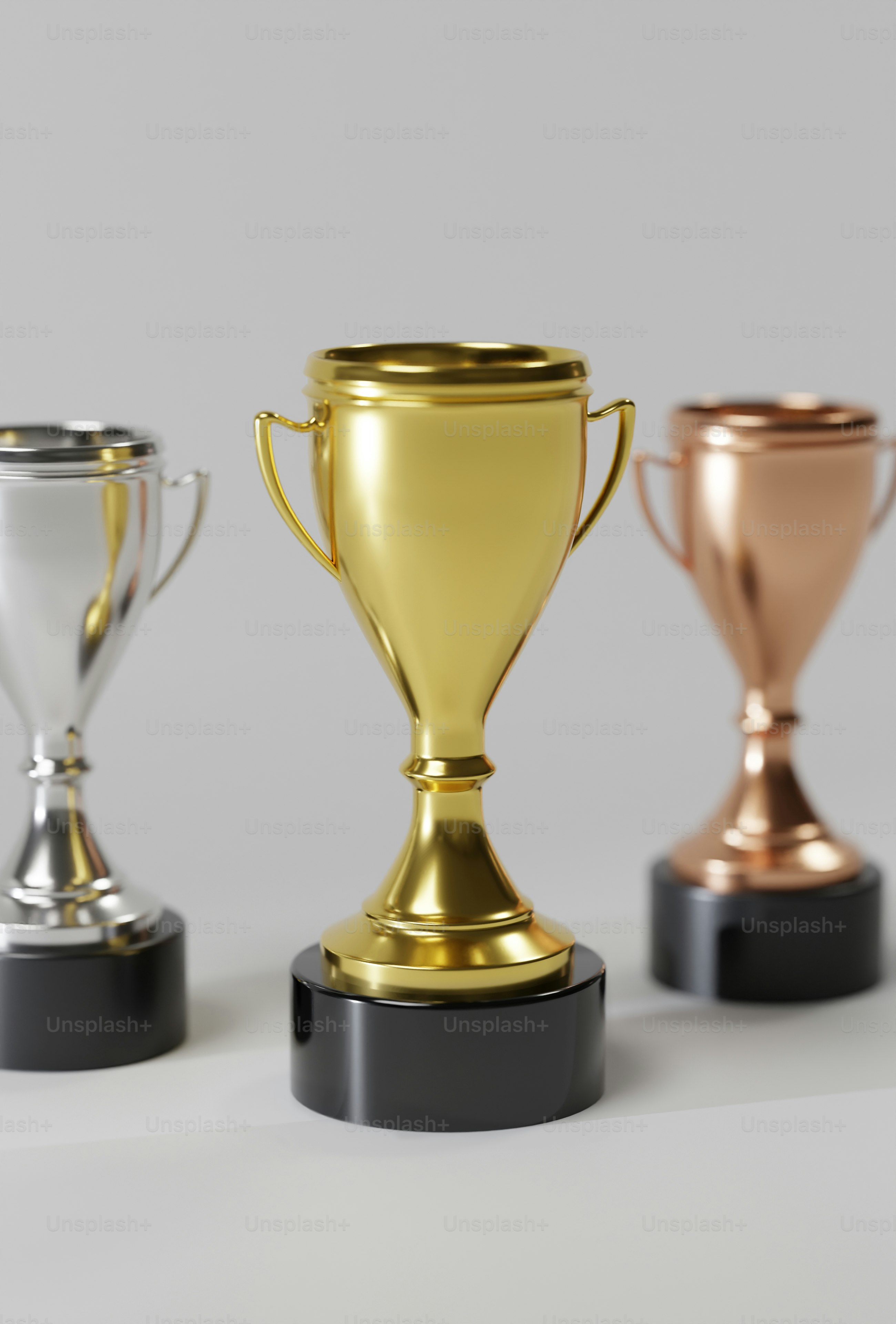 A row of three trophies sitting on top of each other photo – Prize ...