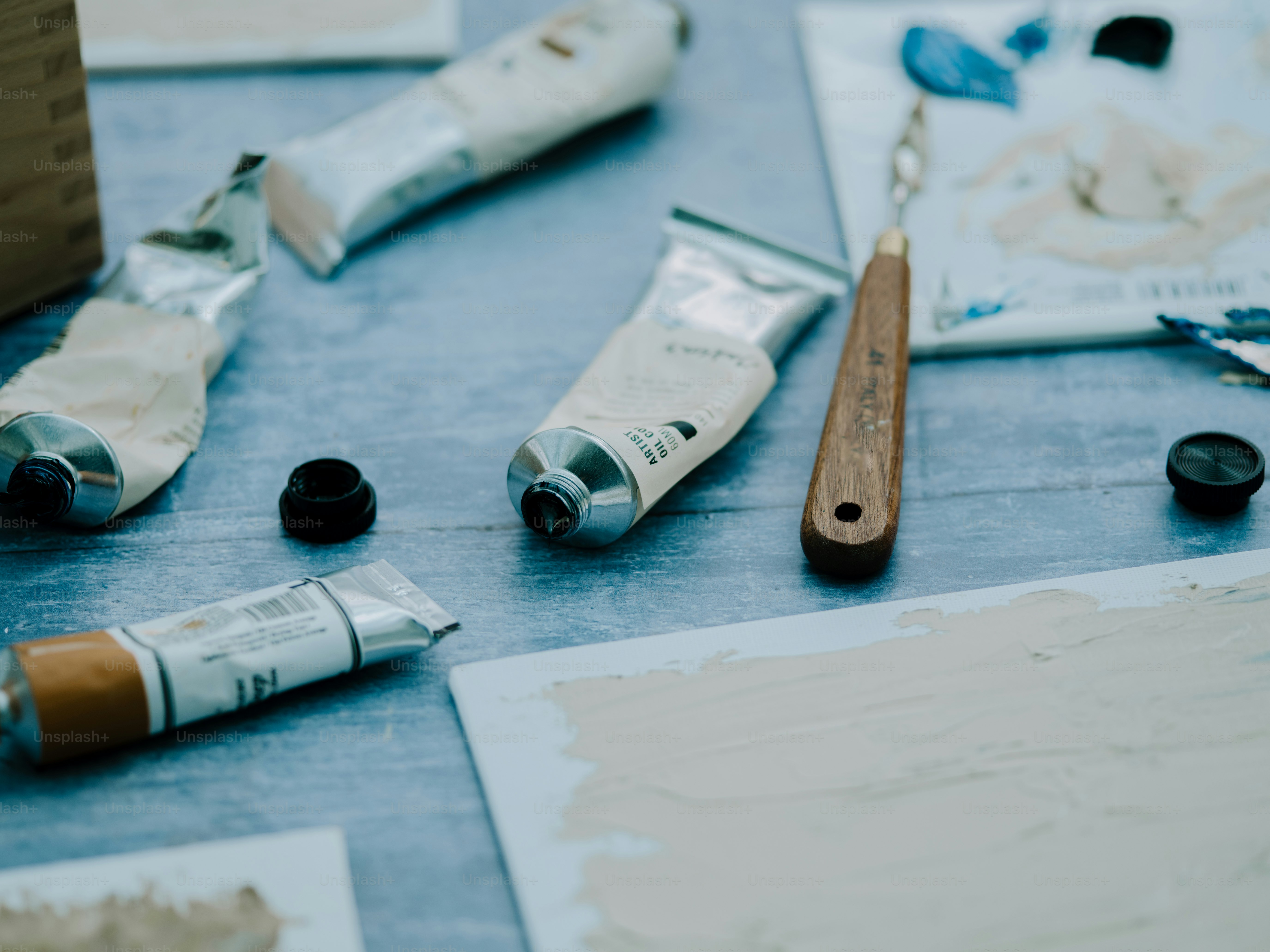 A table topped with lots of different types of paint photo – Artist ...