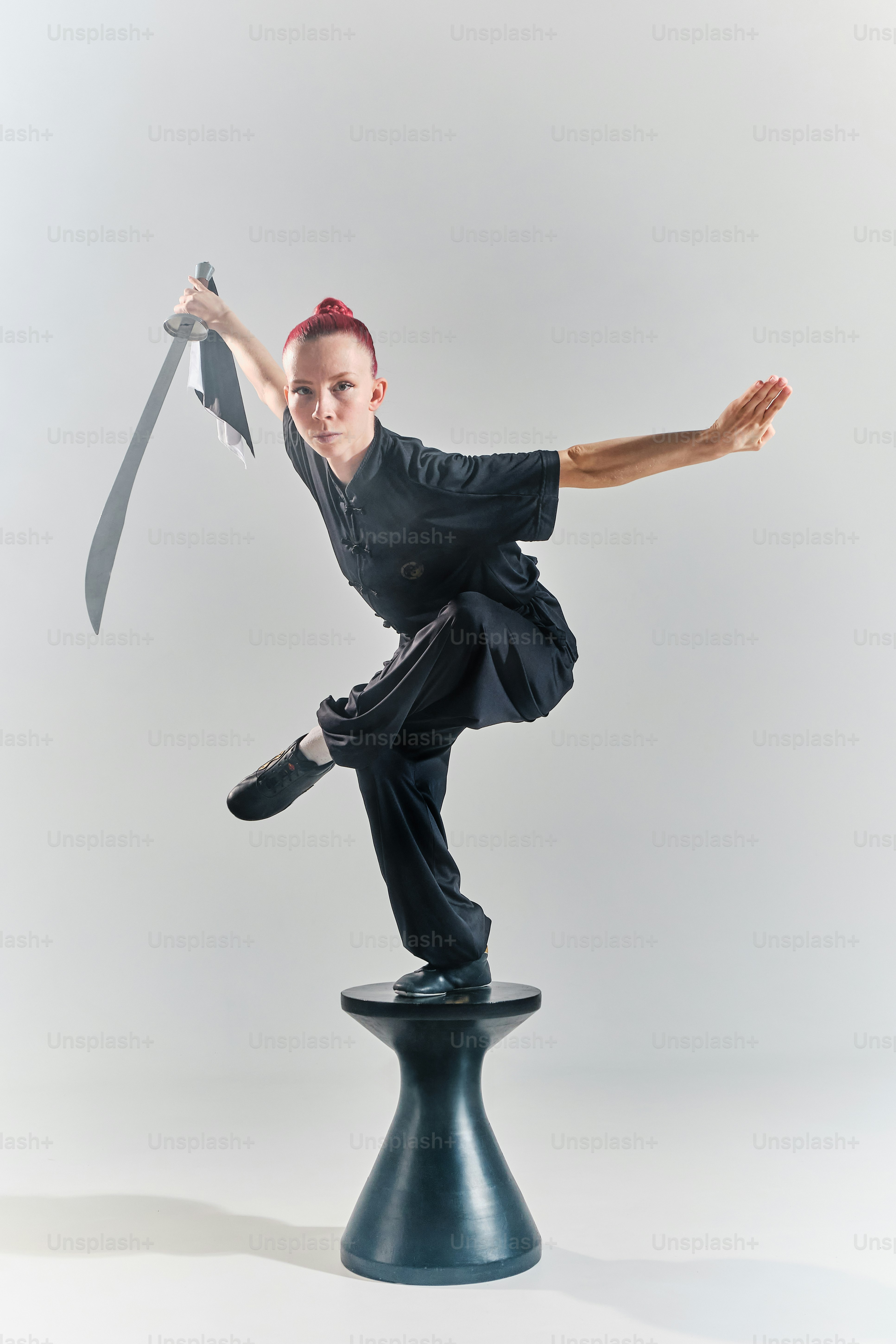 A woman with a knife in her hand on top of a stool photo – Wushu Image ...