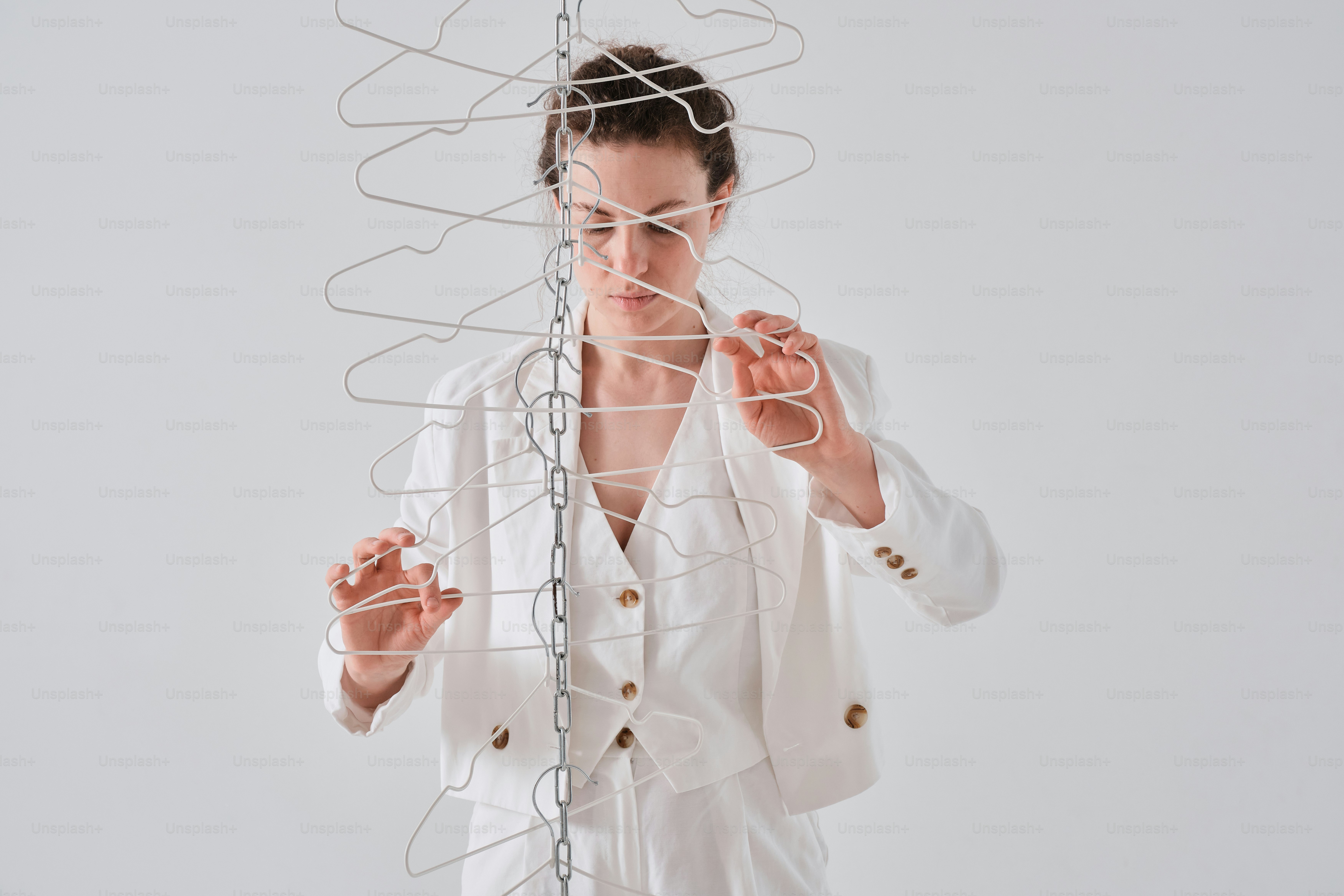 A woman is holding a wire sculpture with her hands photo – Garments ...