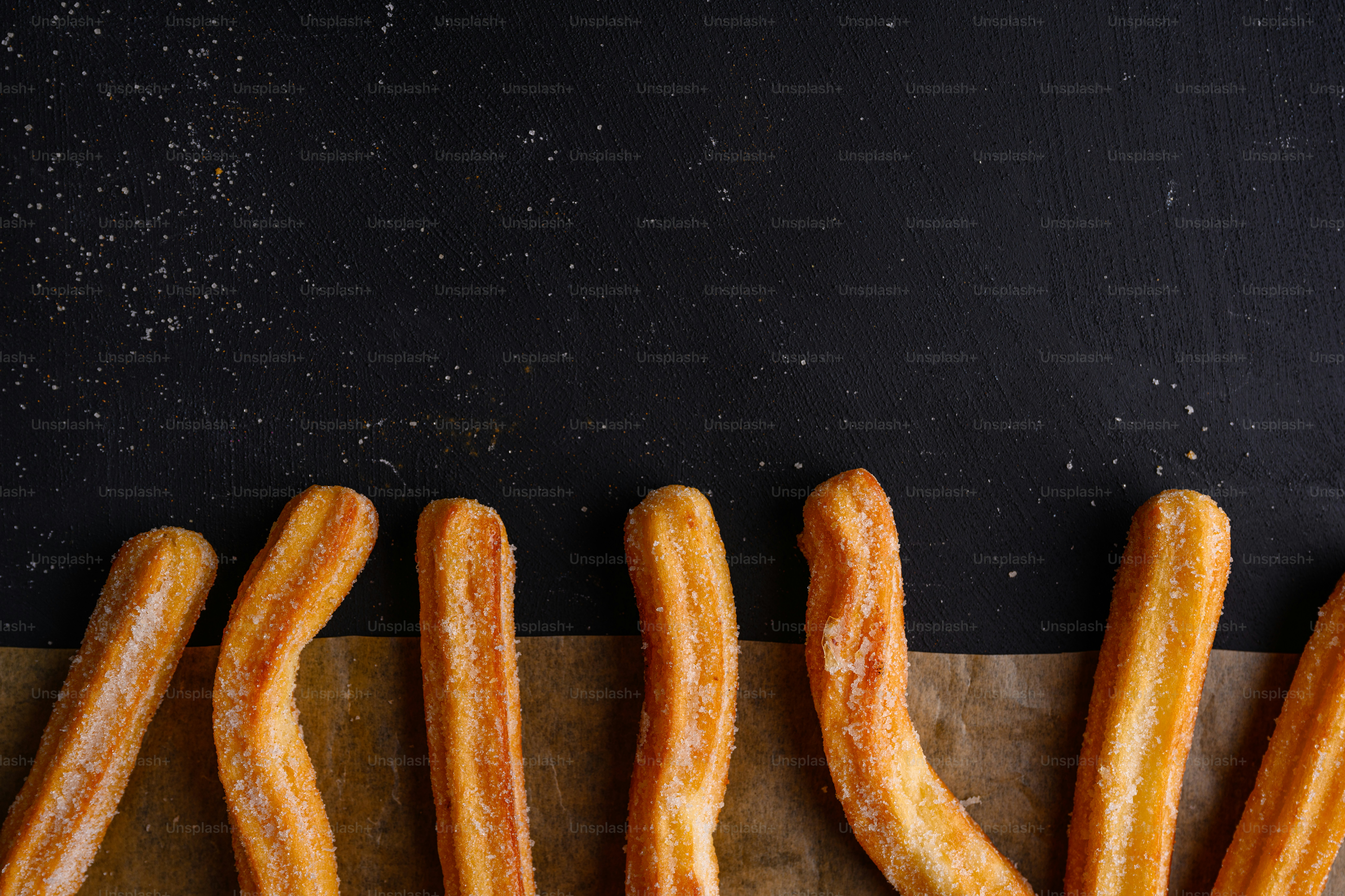 A group of churros sitting on top of a piece of paper photo – Food ...