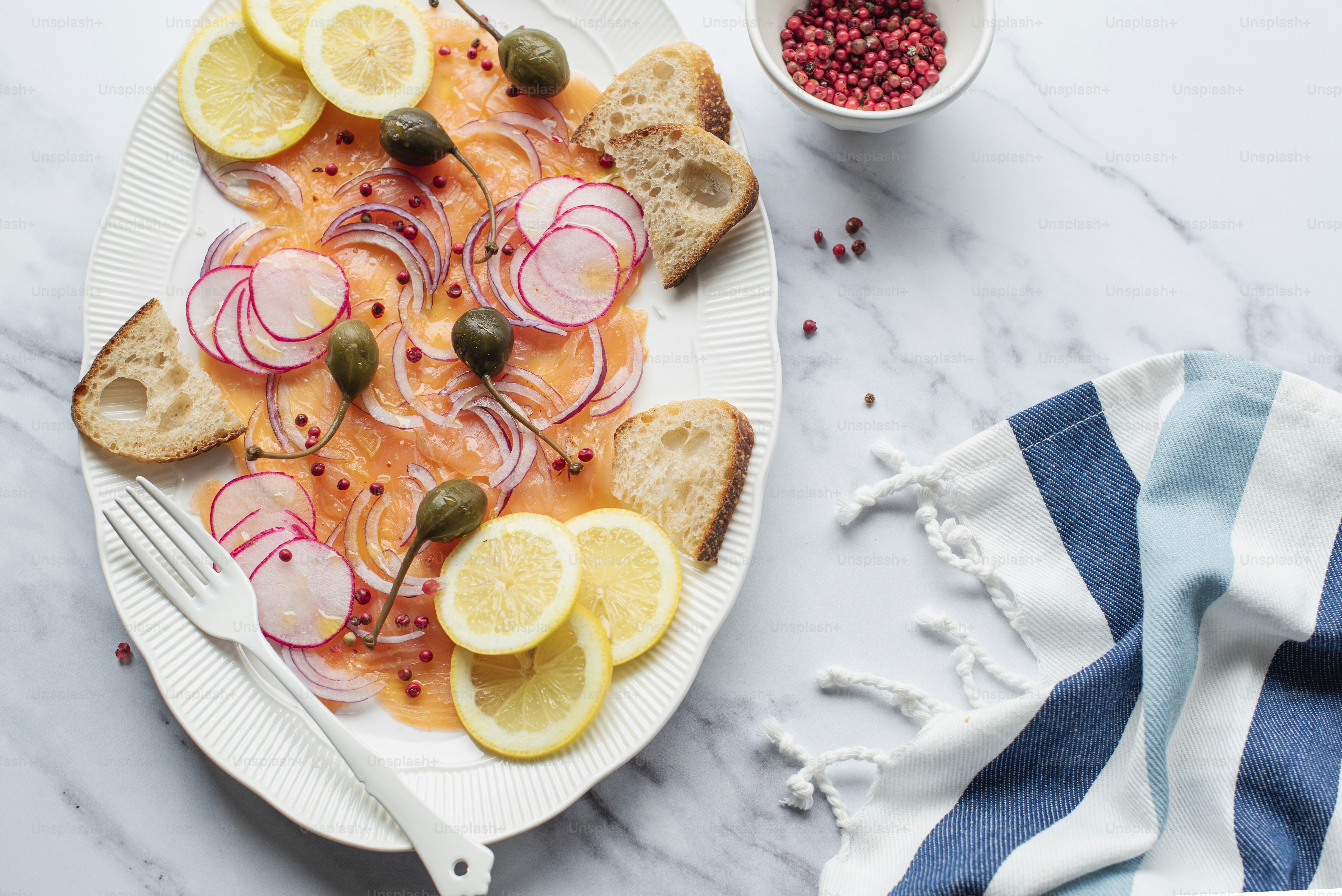 A white plate topped with slices of lemon photo – Sweet treats Image on ...
