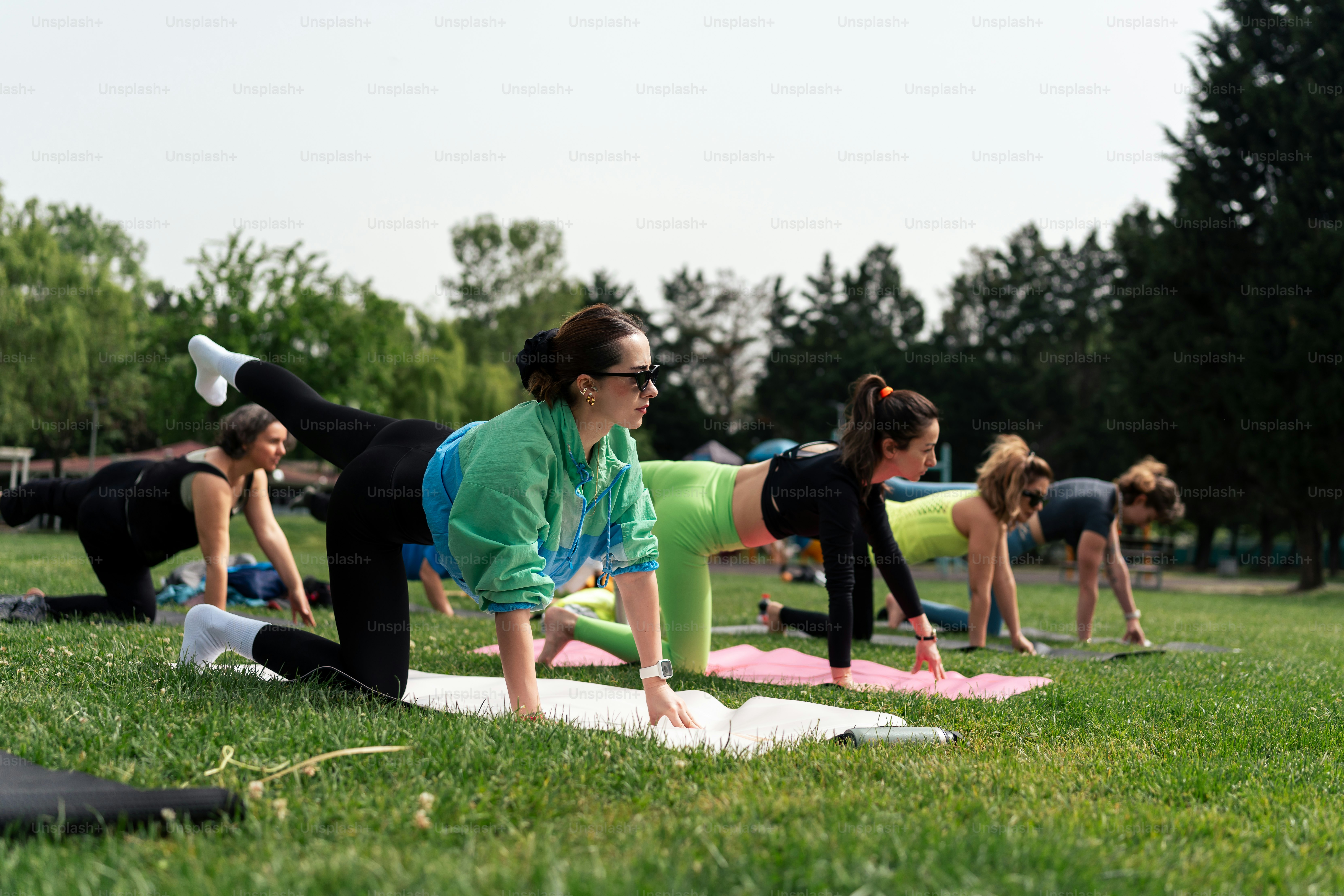 A group of women doing yoga in a park photo – Yoga Image on Unsplash