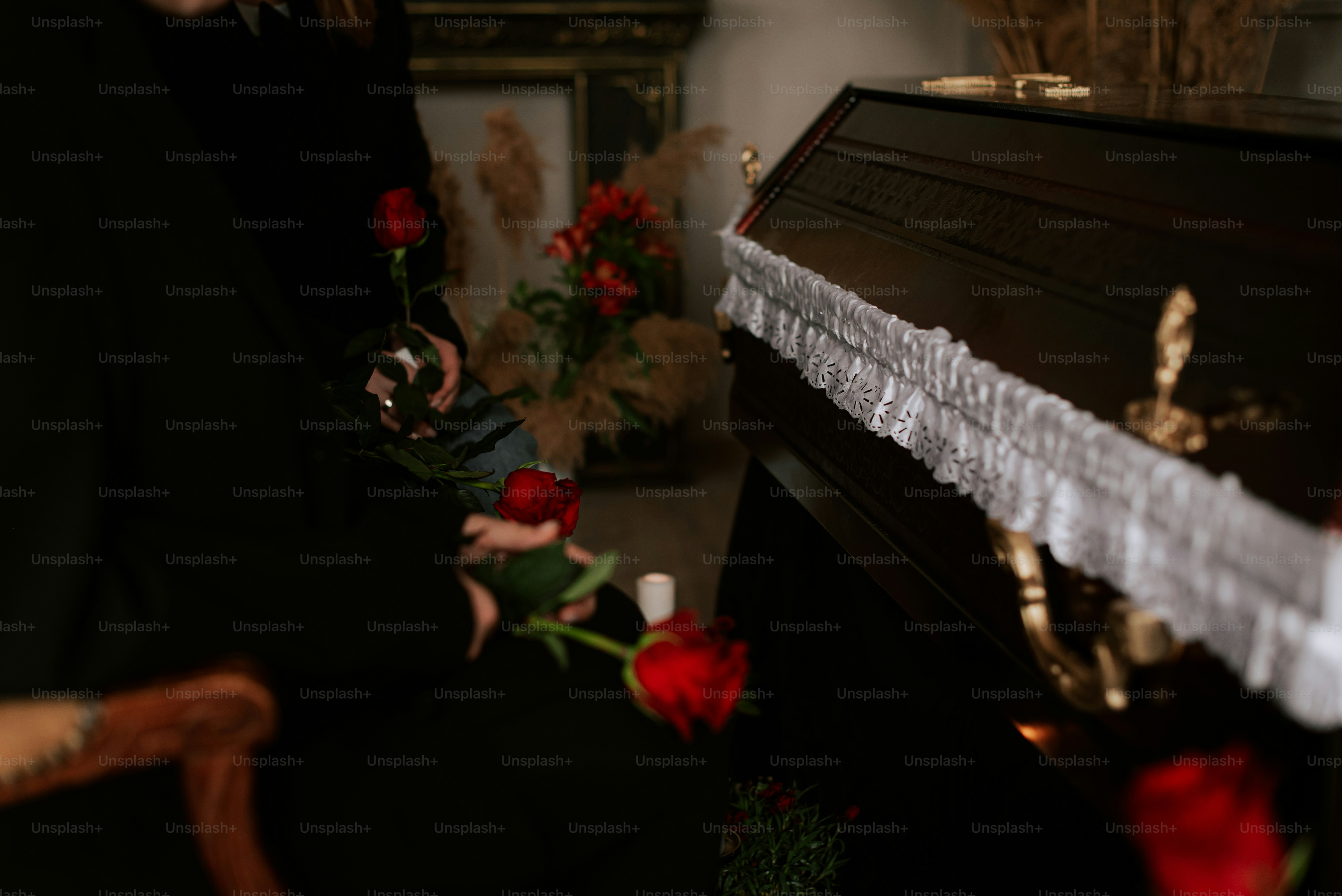 A woman sitting in a chair next to a casket photo – Death Image on Unsplash