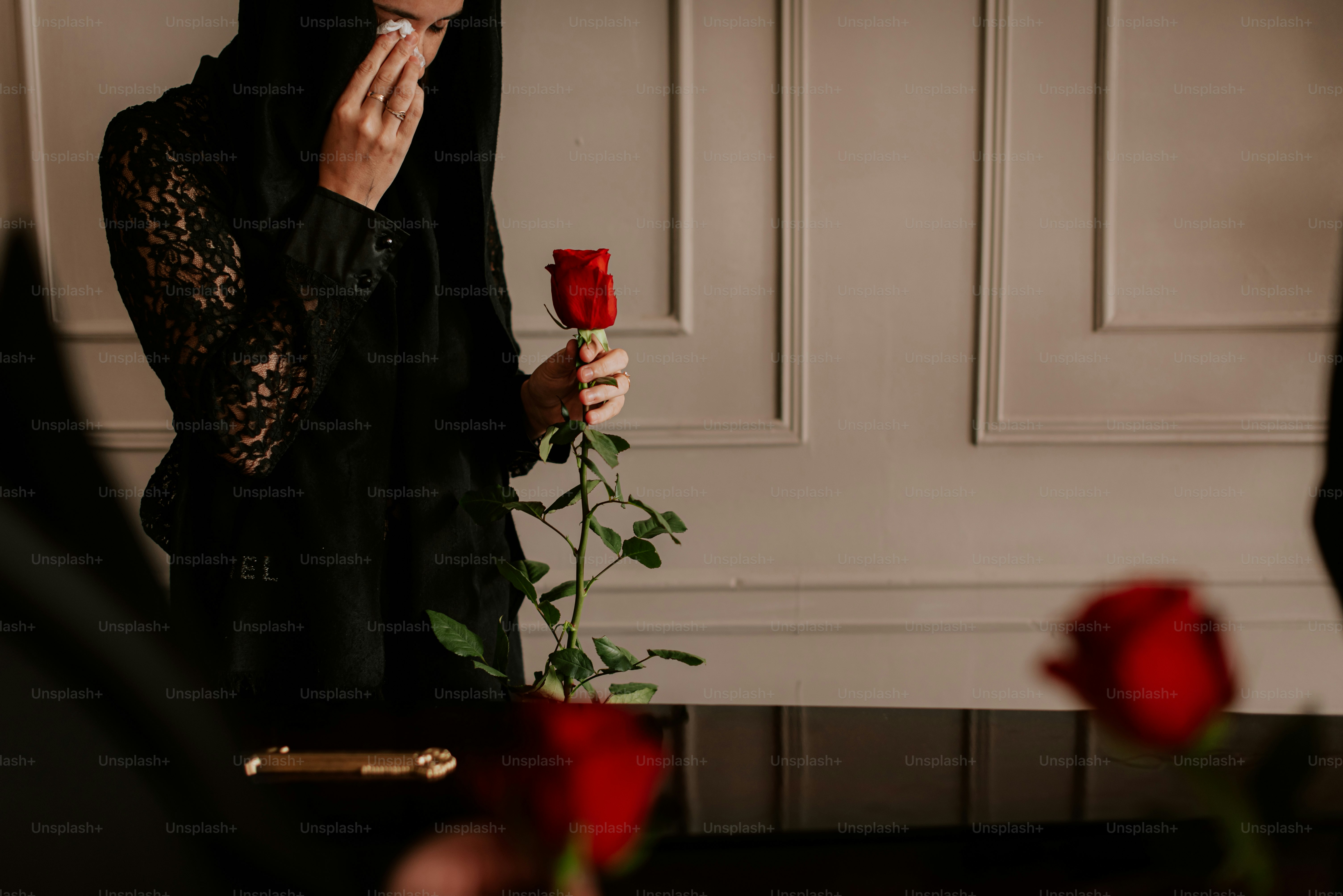 A woman is holding a rose in her hand photo – Death Image on Unsplash