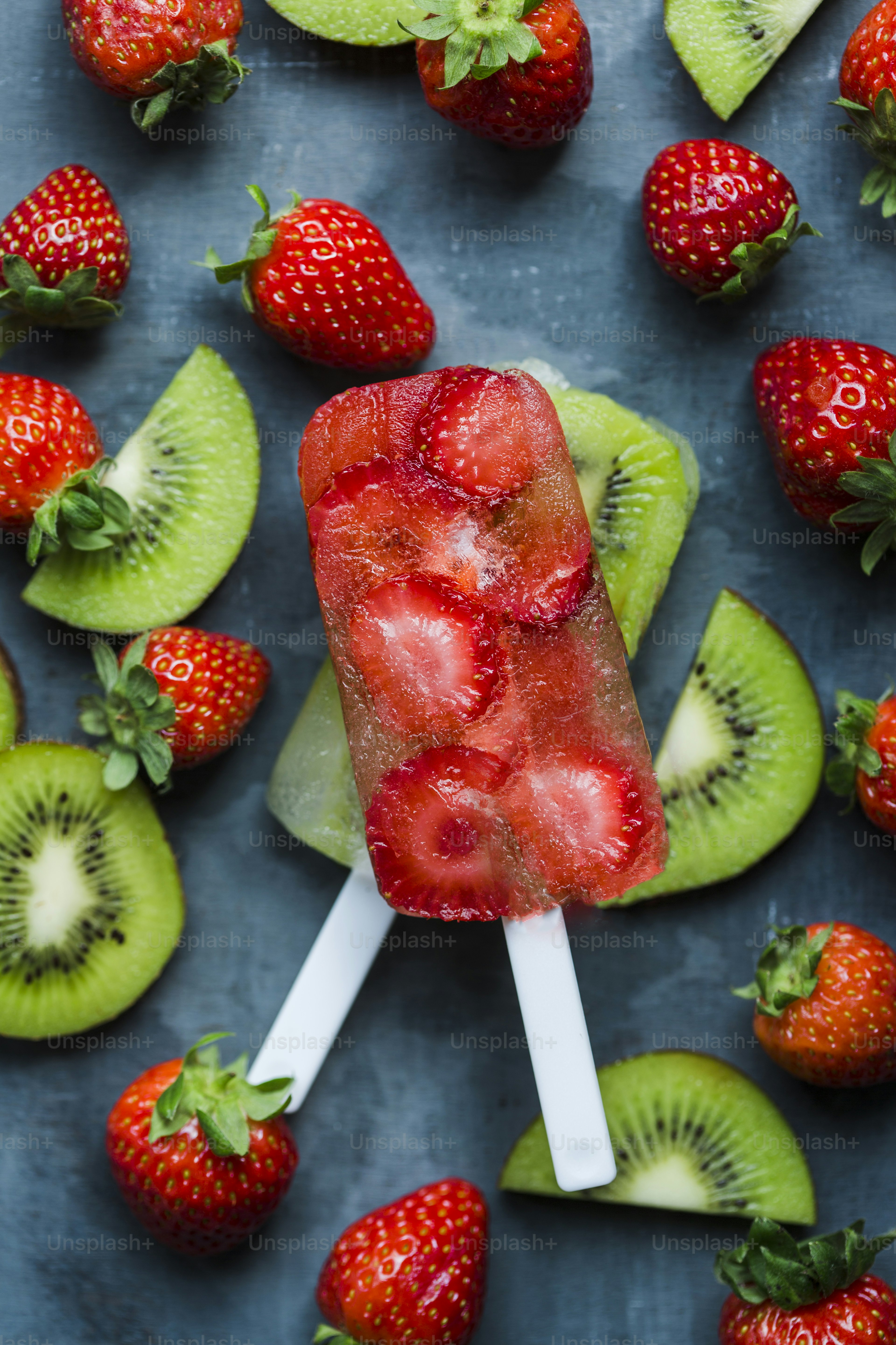 A popsicle with kiwi and strawberries on a table photo – Summer food ...