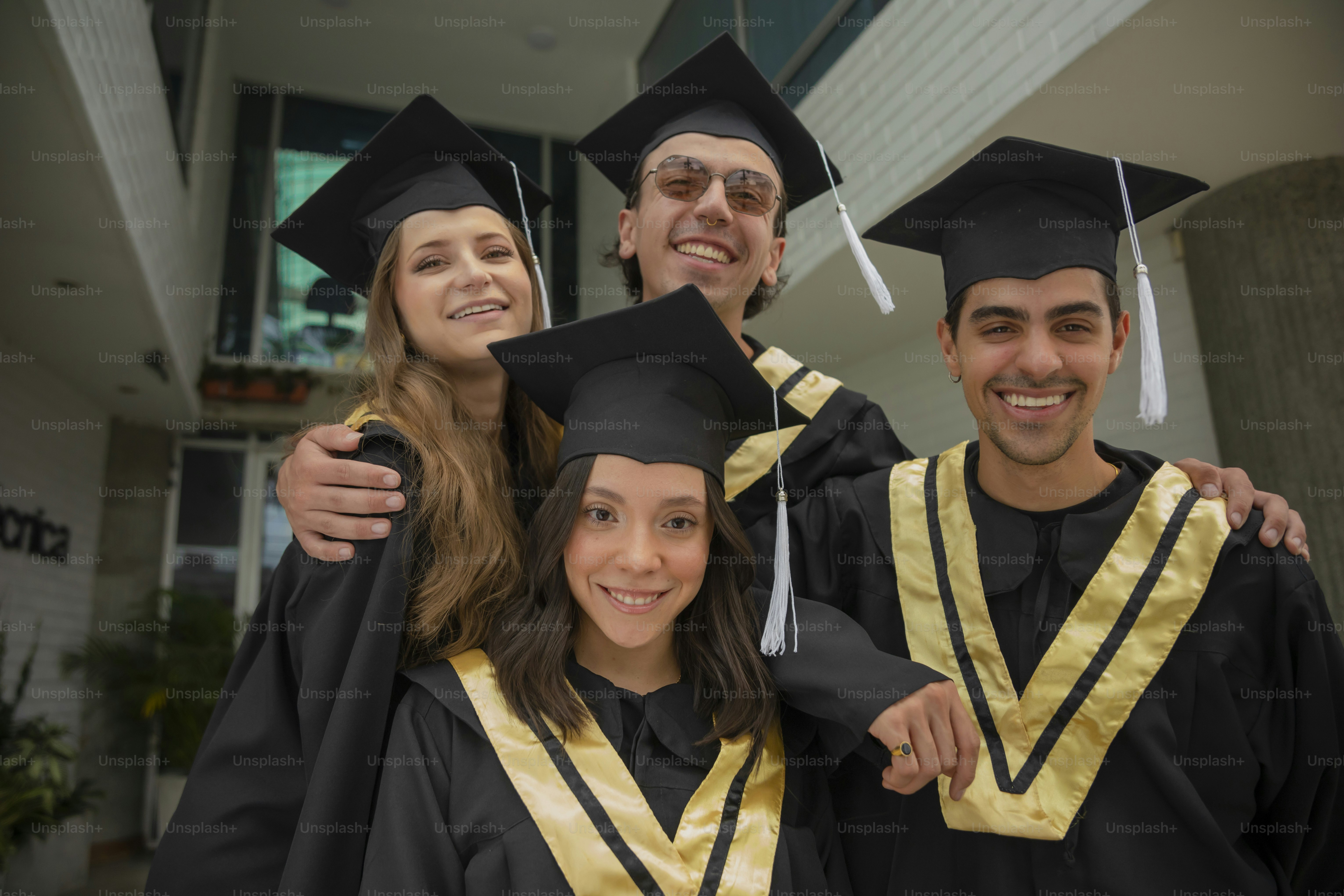 A group of people in graduation gowns posing for a picture photo ...
