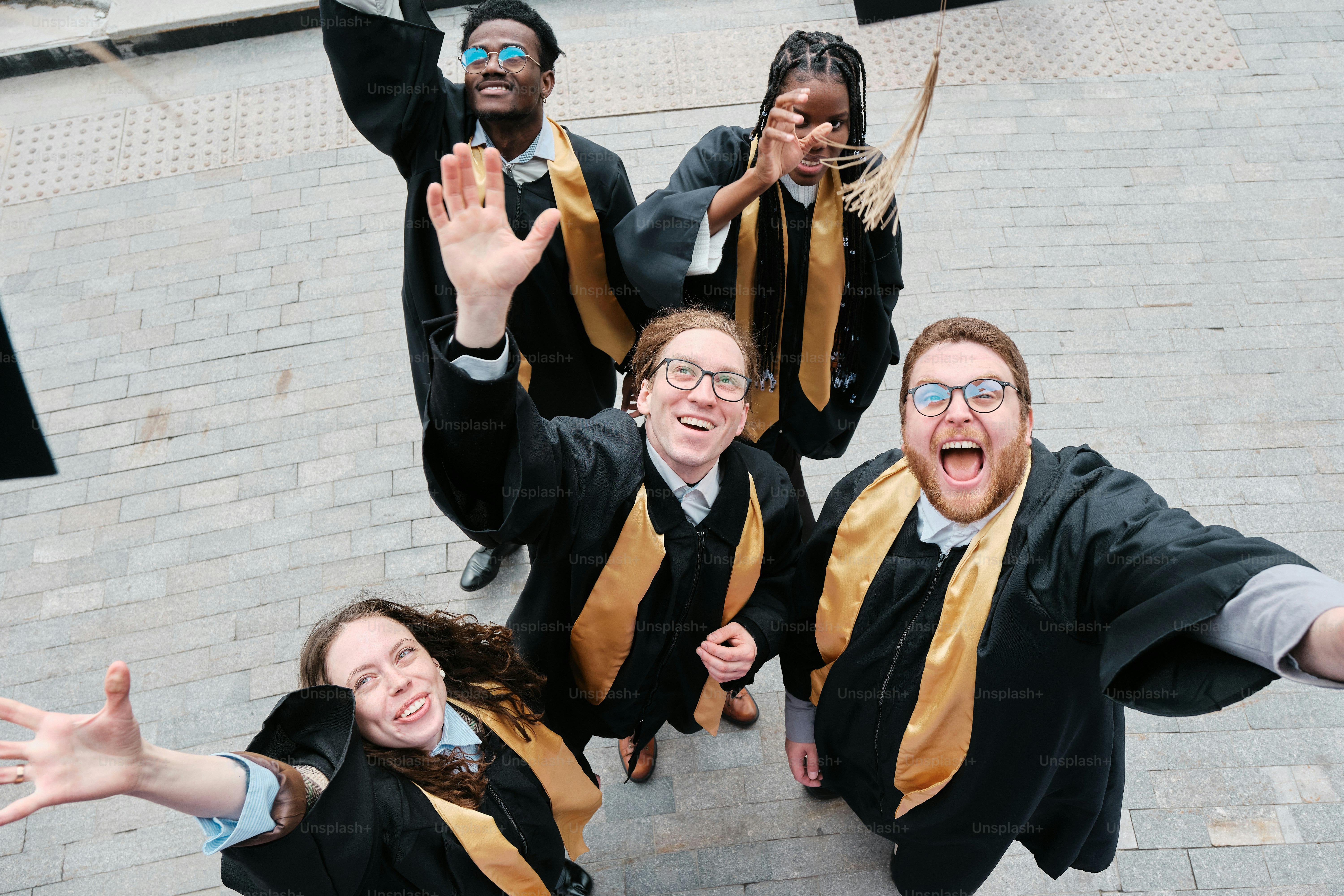 A group of people in graduation gowns standing on a stage photo ...