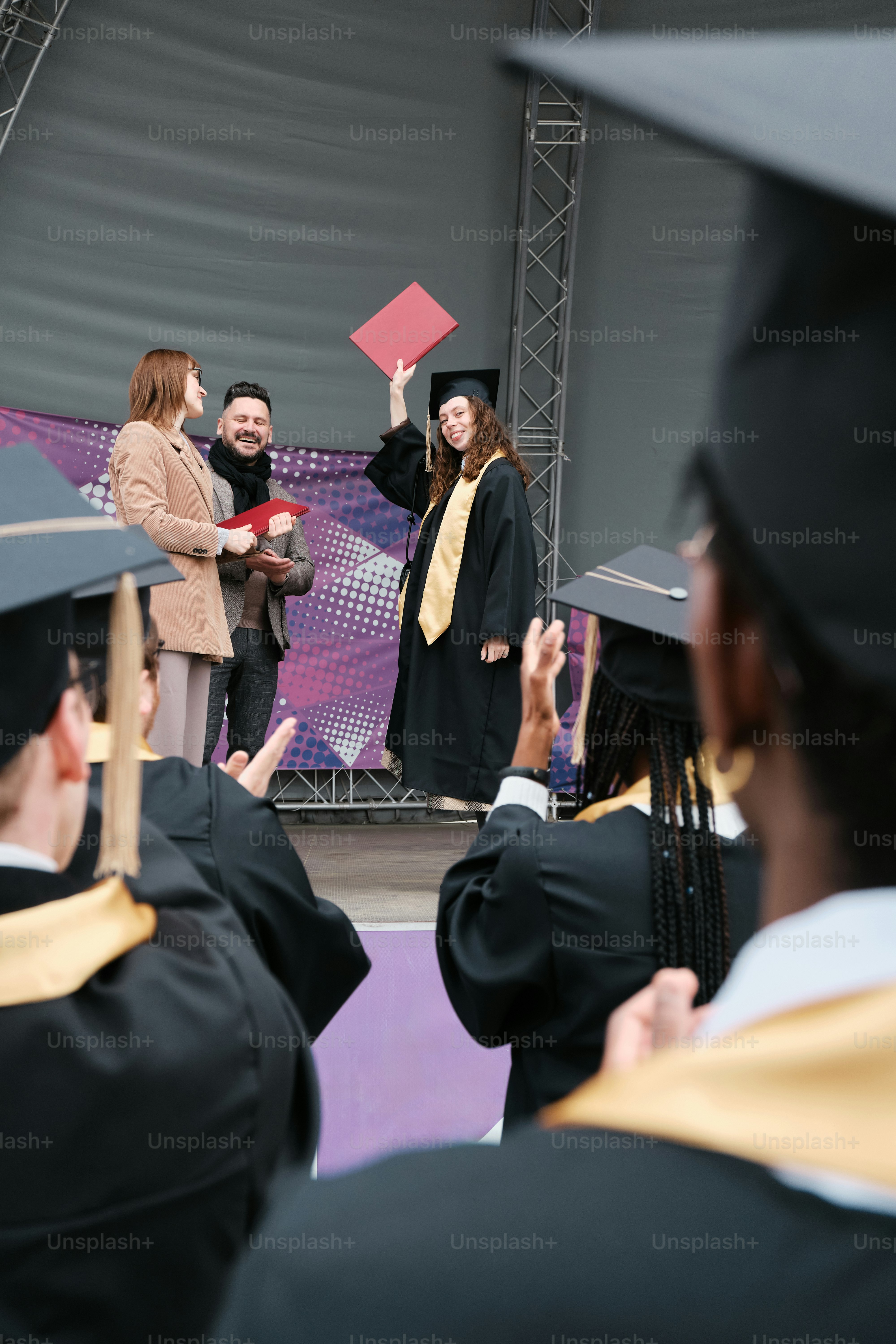 A group of people standing on top of a stage photo – Graduation Image ...