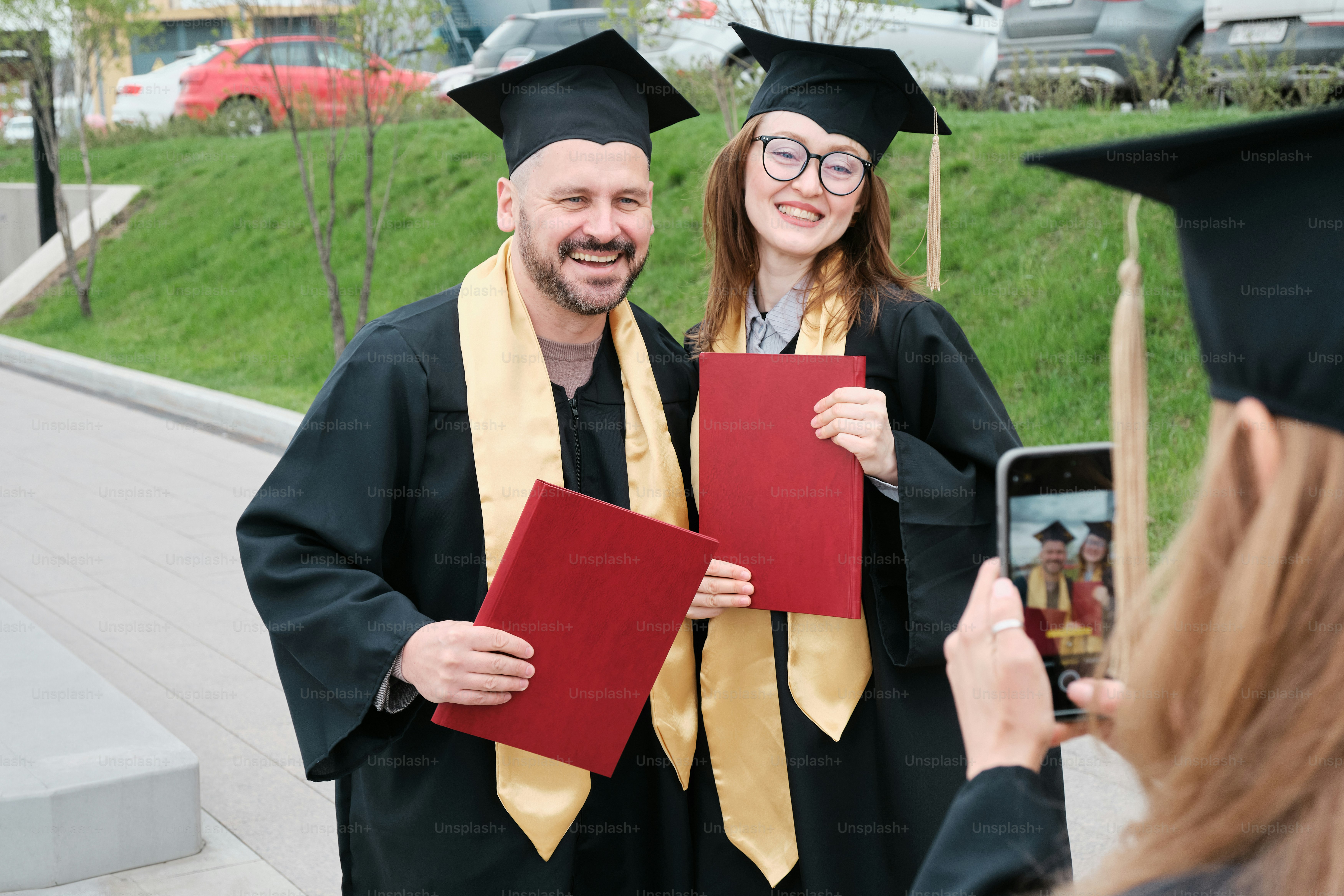 A couple of people that are standing in the grass photo – Graduation ...