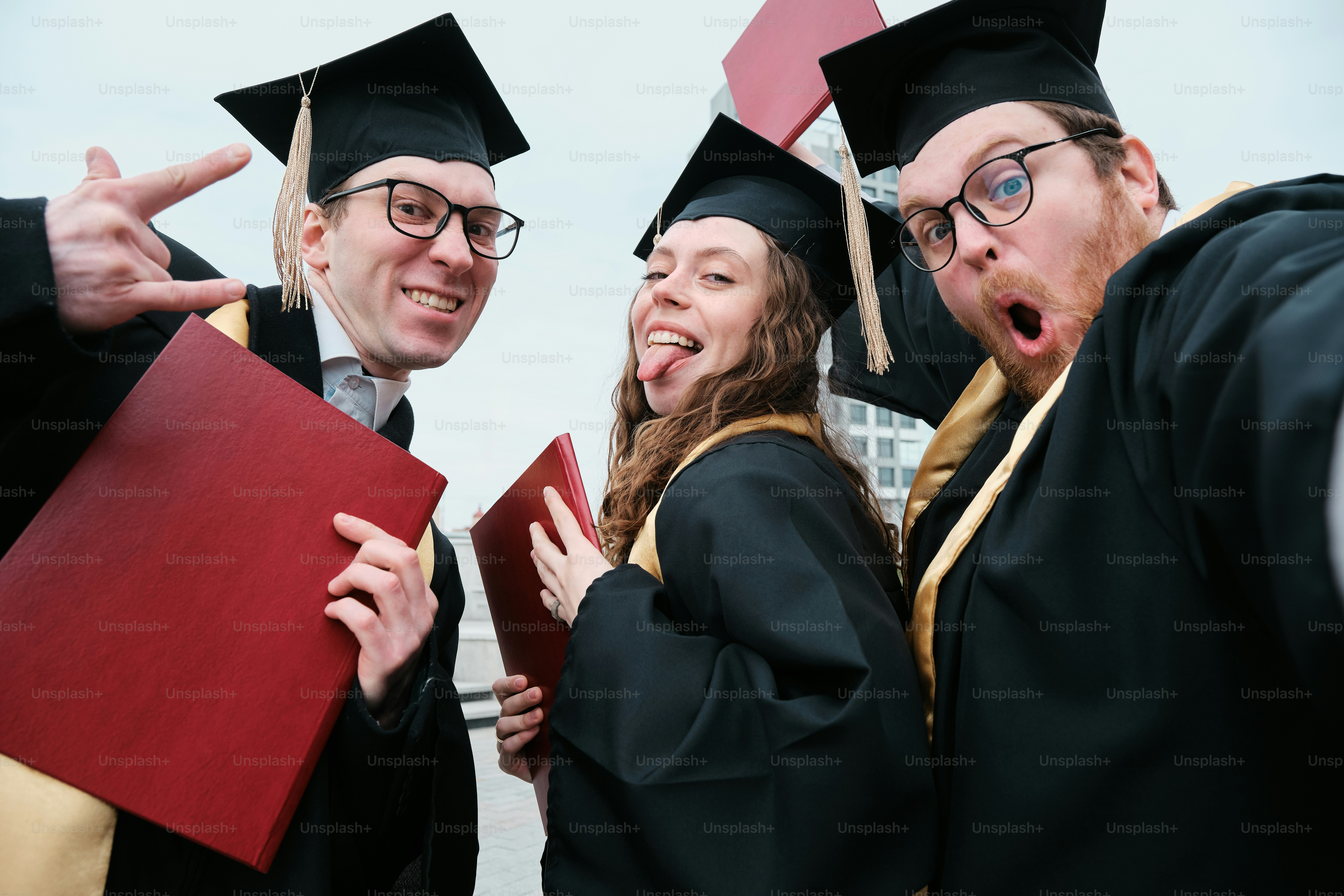 A group of people in graduation gowns standing on a stage photo ...