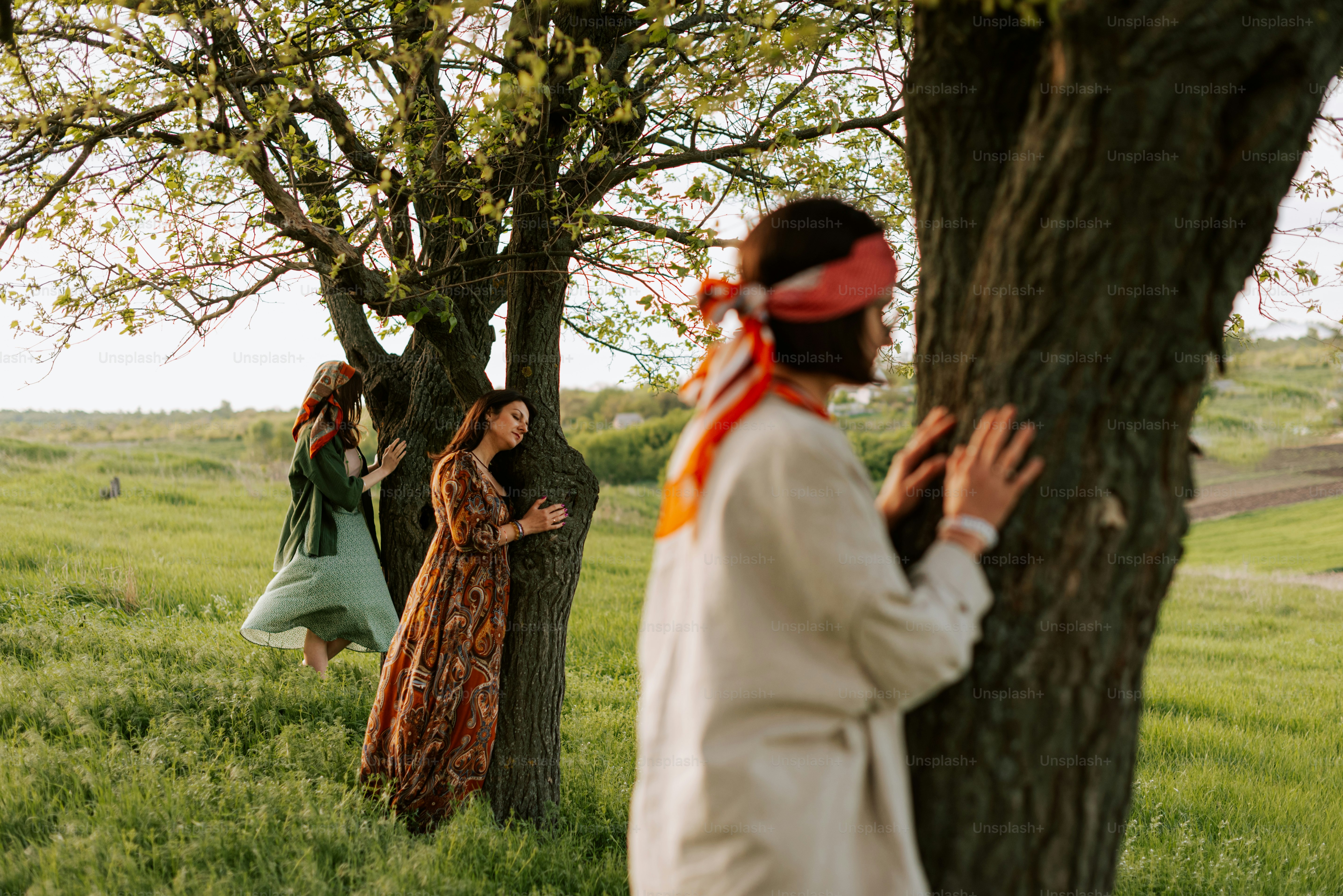 A group of people standing around a tree photo – Health Image on Unsplash