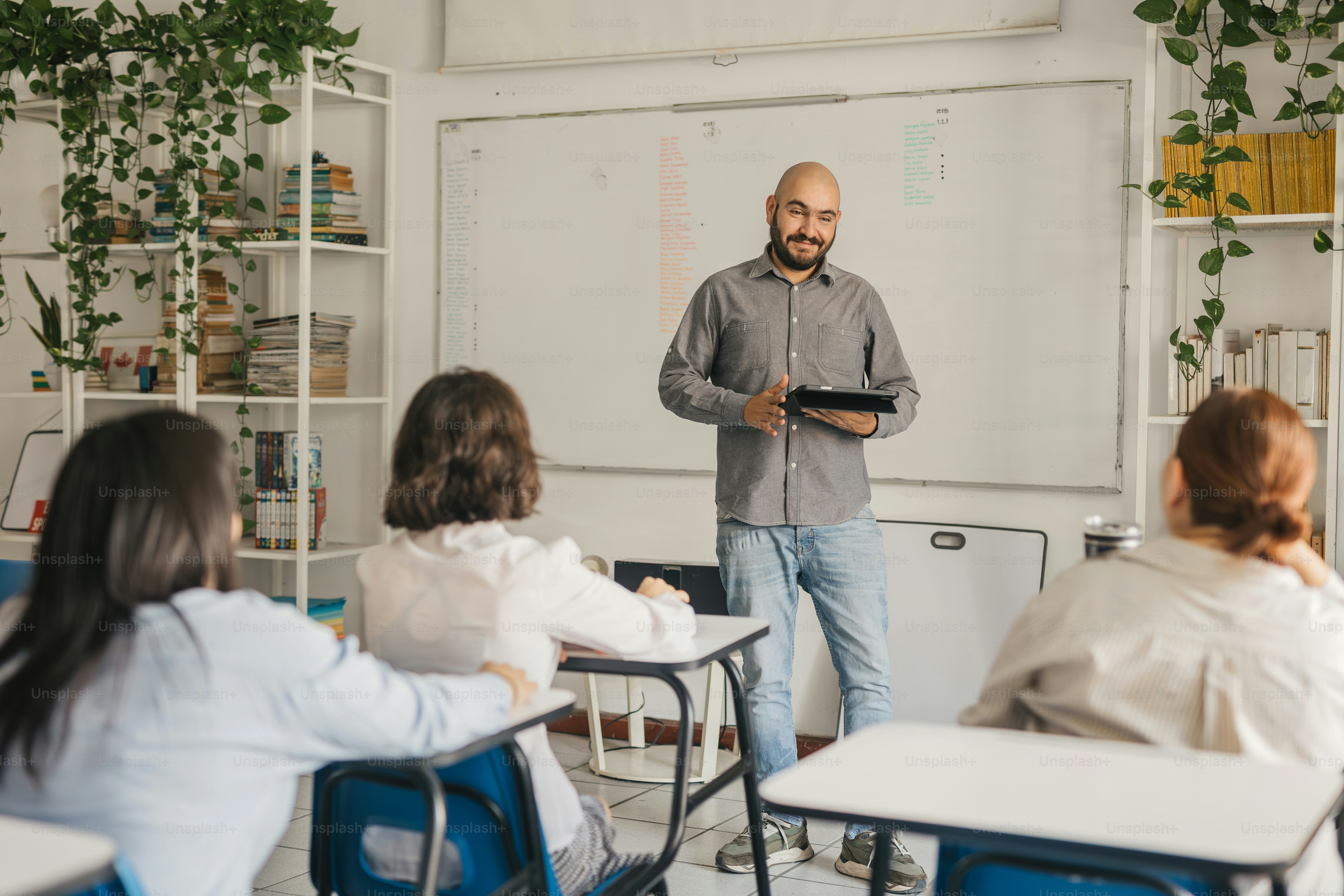 A man standing in front of a classroom full of students photo – Adult ...