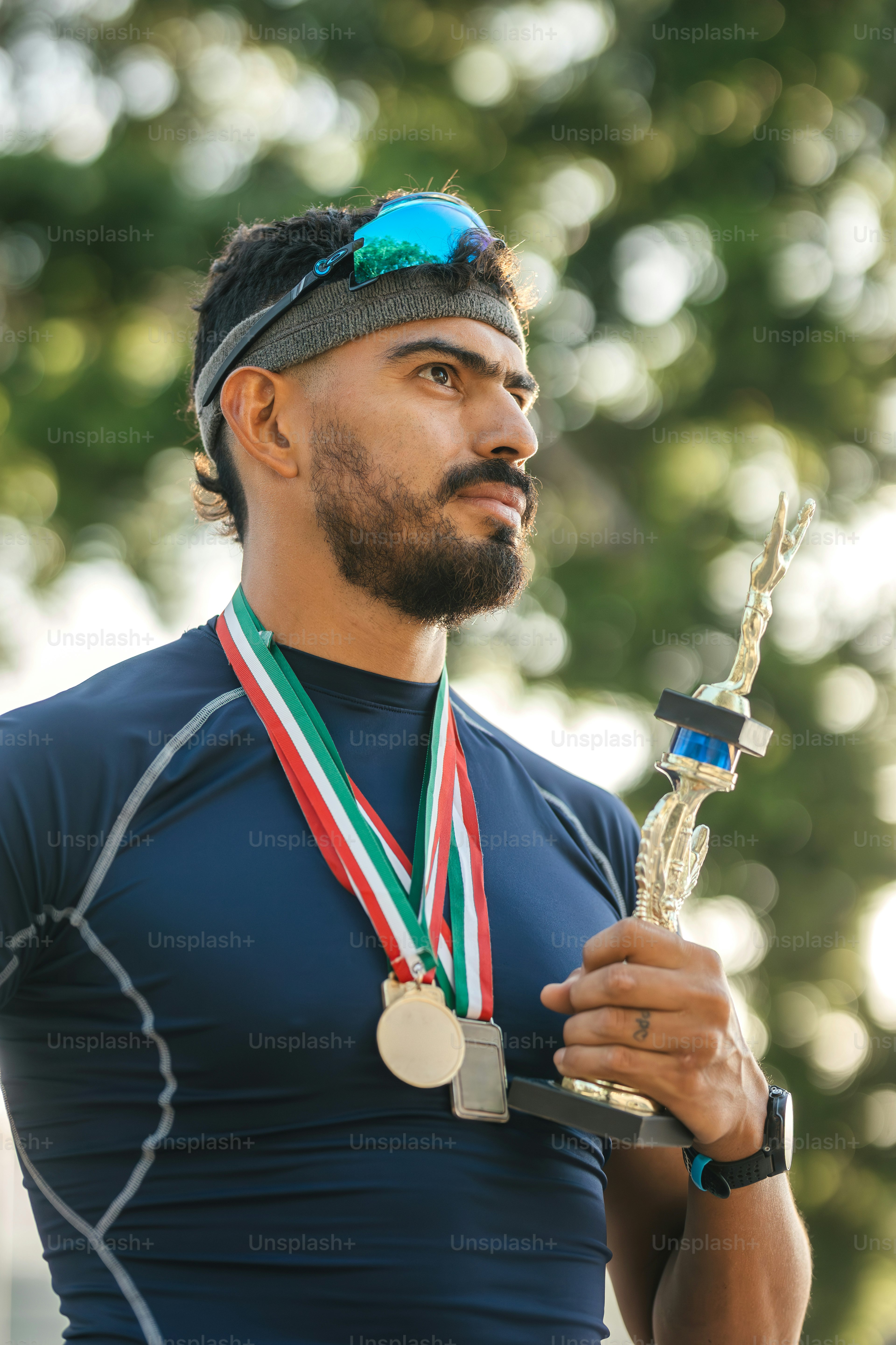 A man with a medal and a medal around his neck photo – Success Image on ...