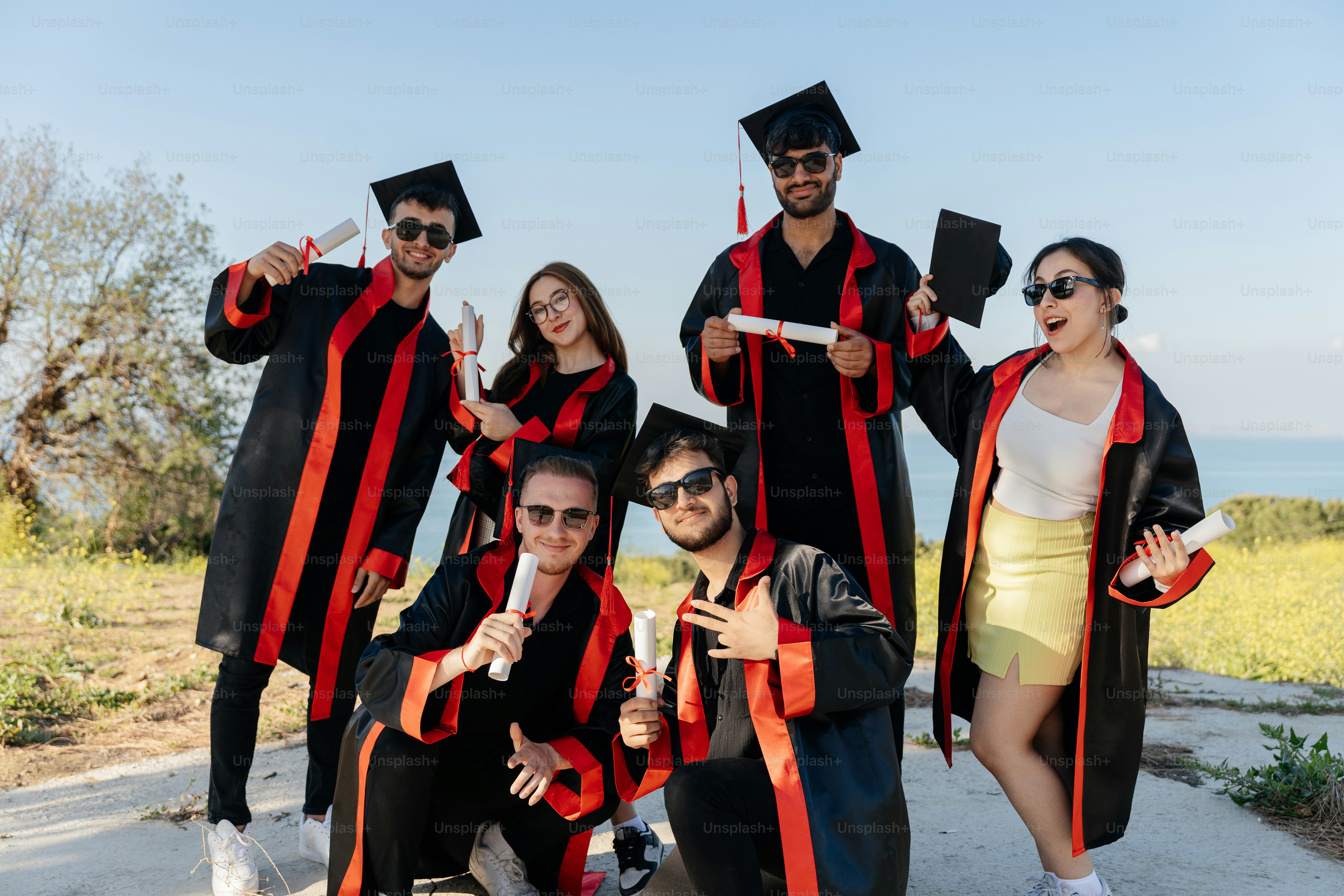A group of people in graduation gowns walking down a street photo ...