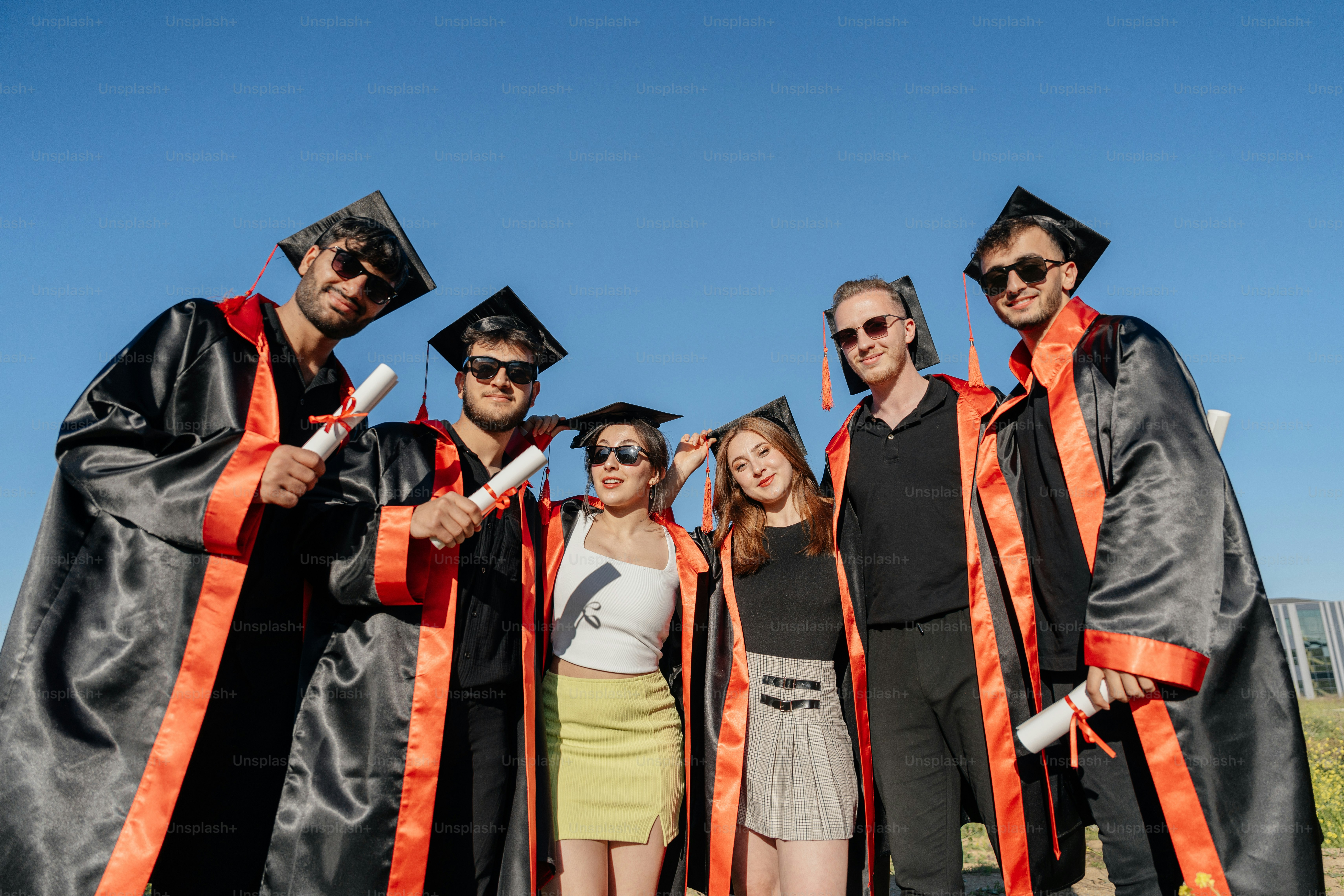 A woman in a black and orange graduation gown photo – Graduation Image ...