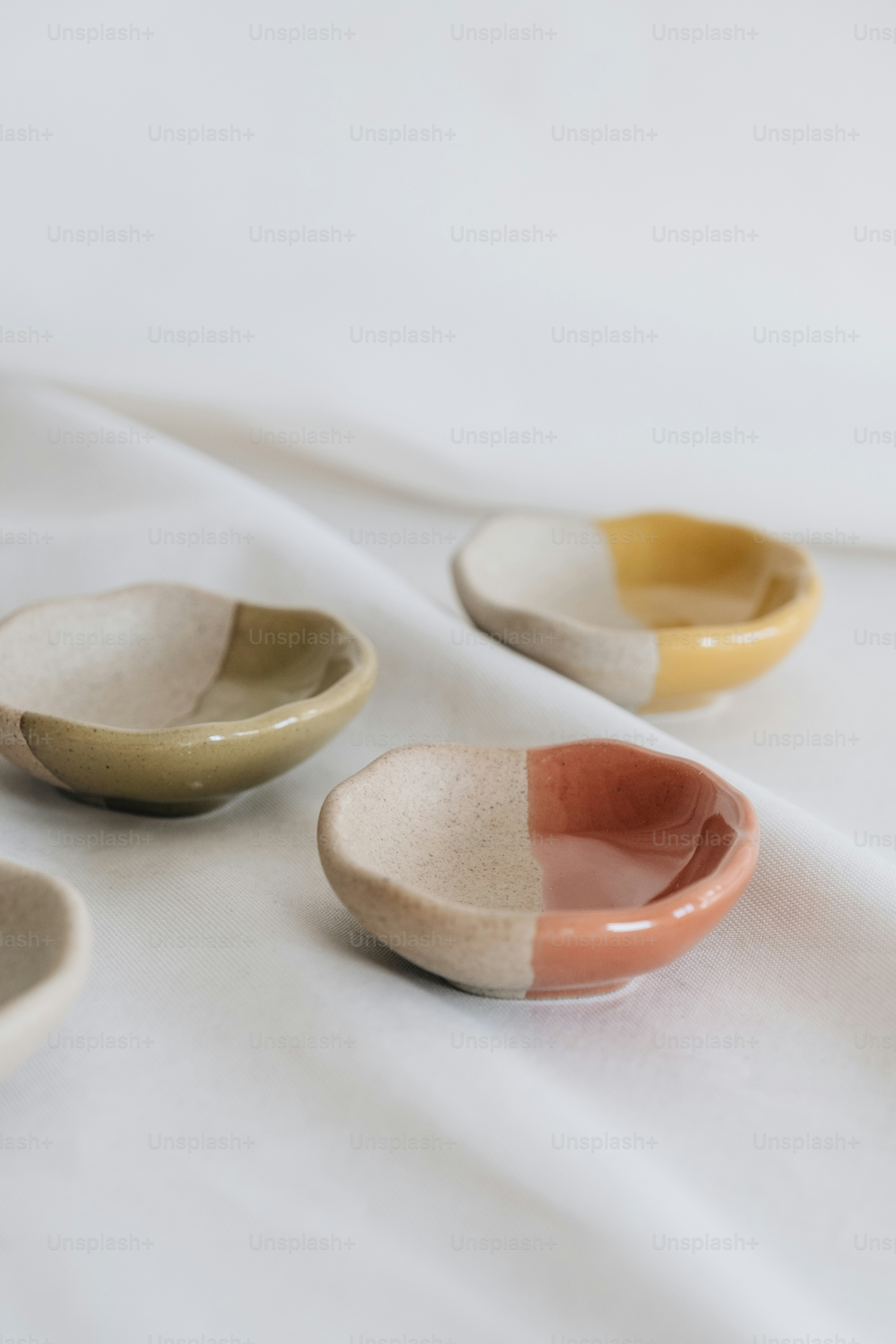 A group of four bowls sitting on top of a white table photo ...