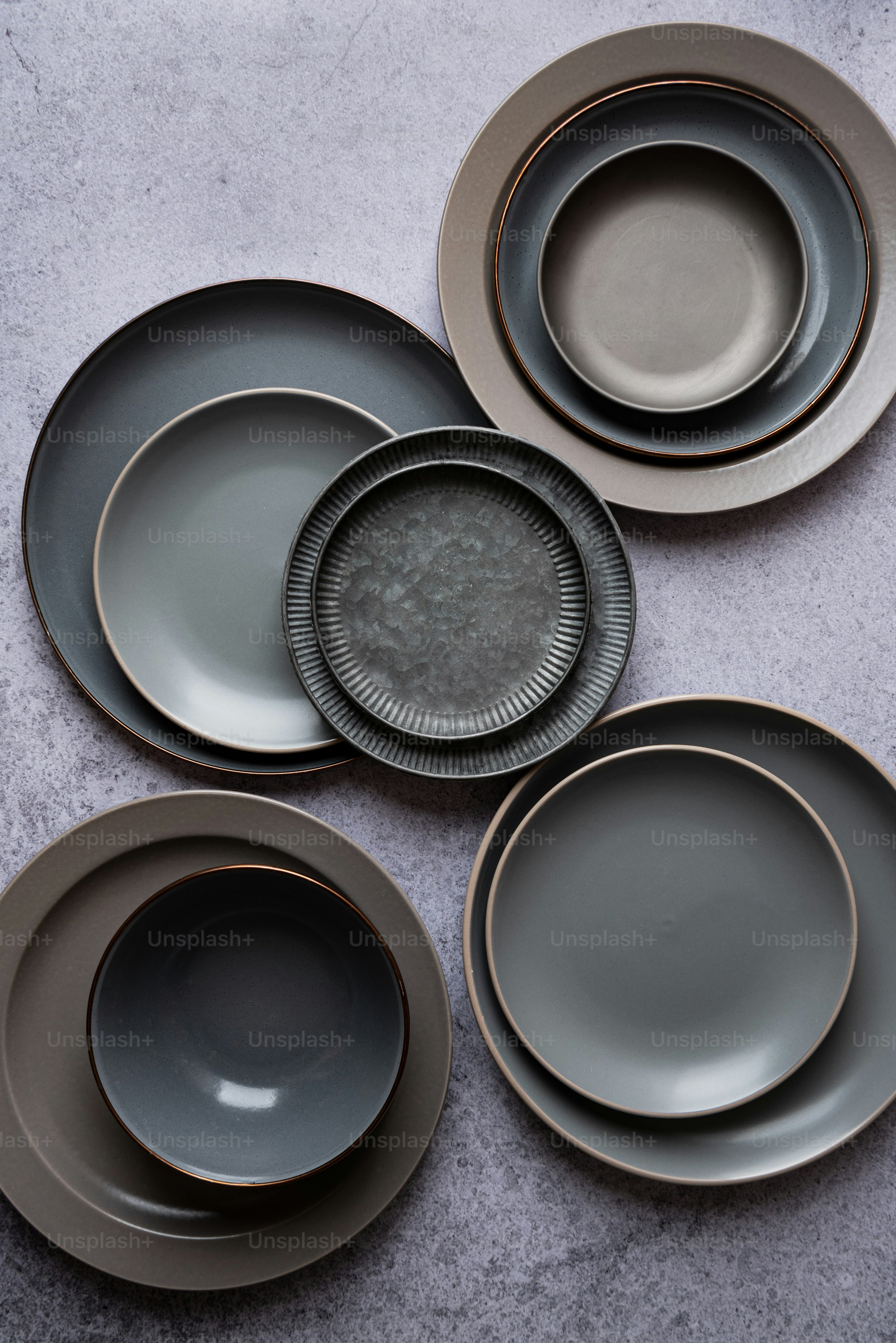 A table topped with plates and bowls on top of a table photo – Plates ...