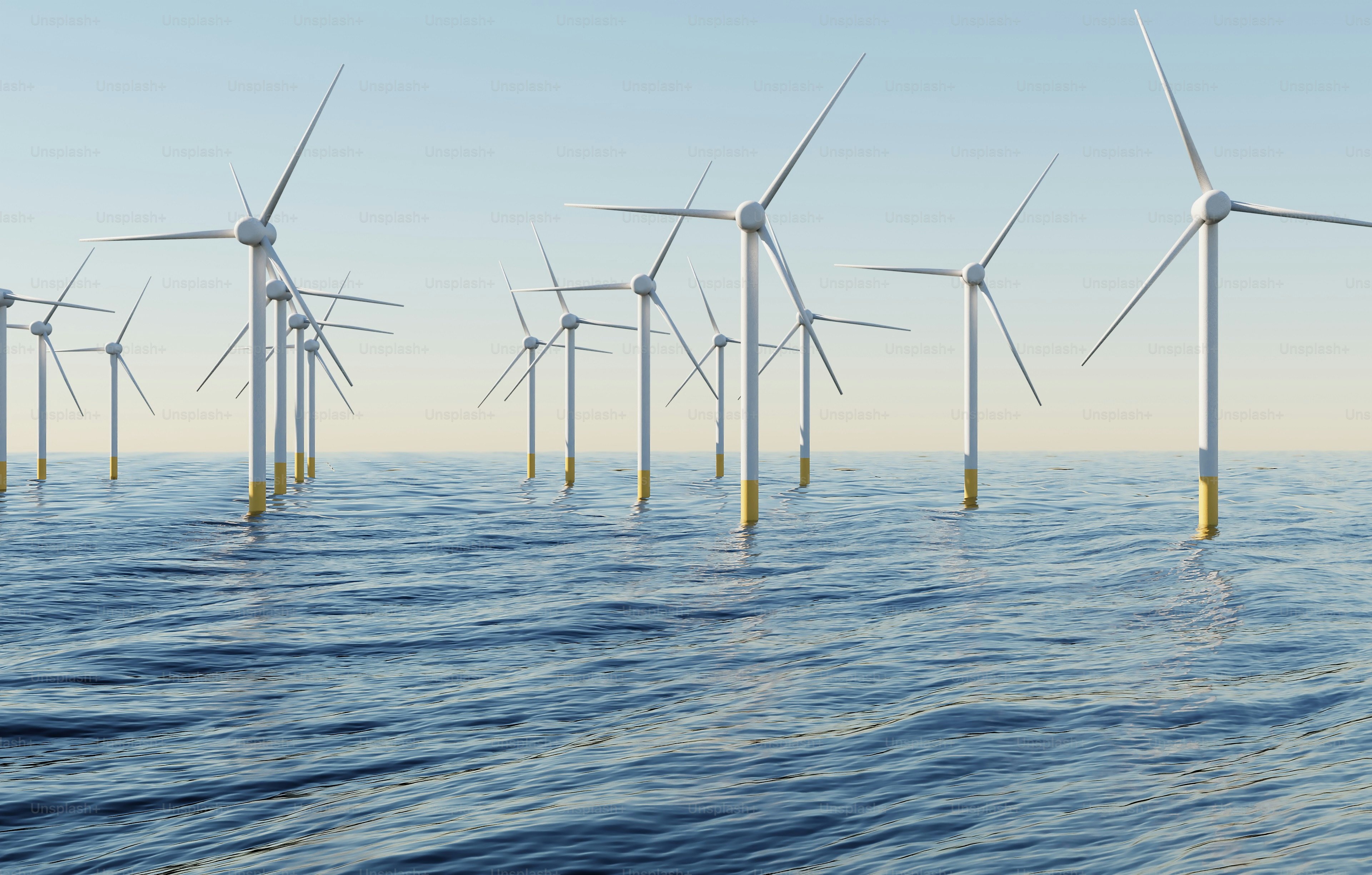 A row of wind turbines floating on top of a body of water photo ...