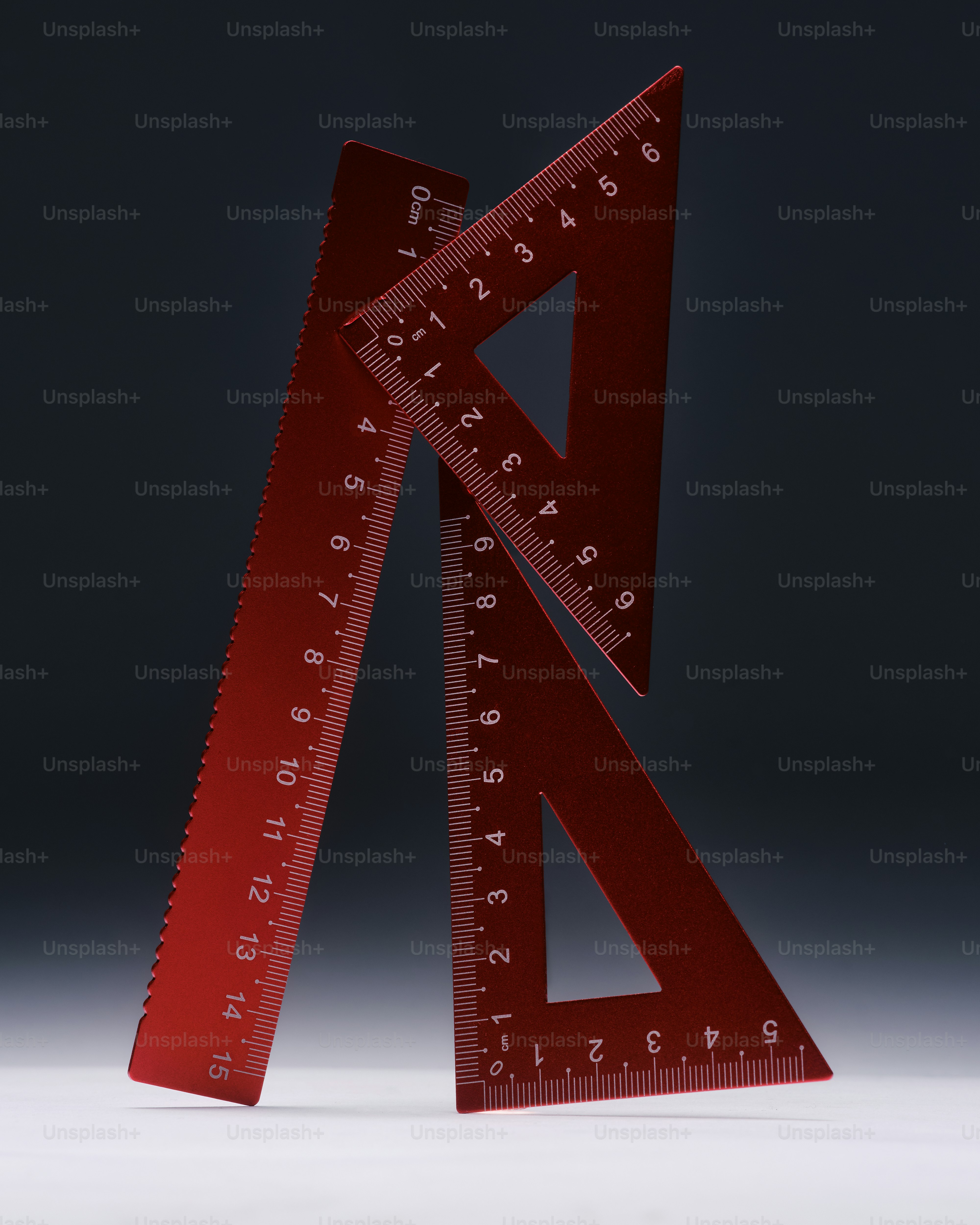 A pair of red rulers with a ruler on top of them photo – Learning Image ...