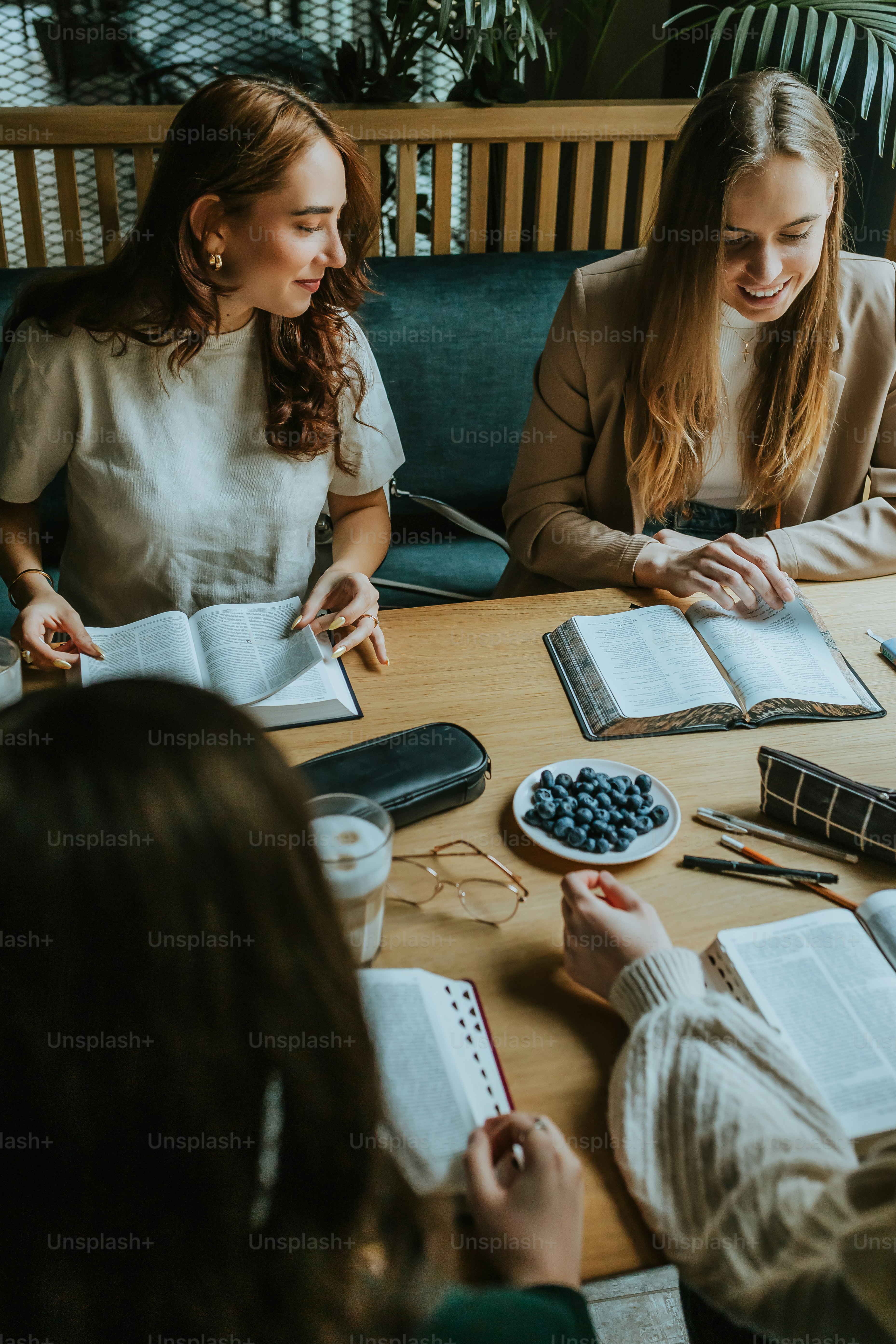 A group of women sitting around a wooden table photo – Youth group ...