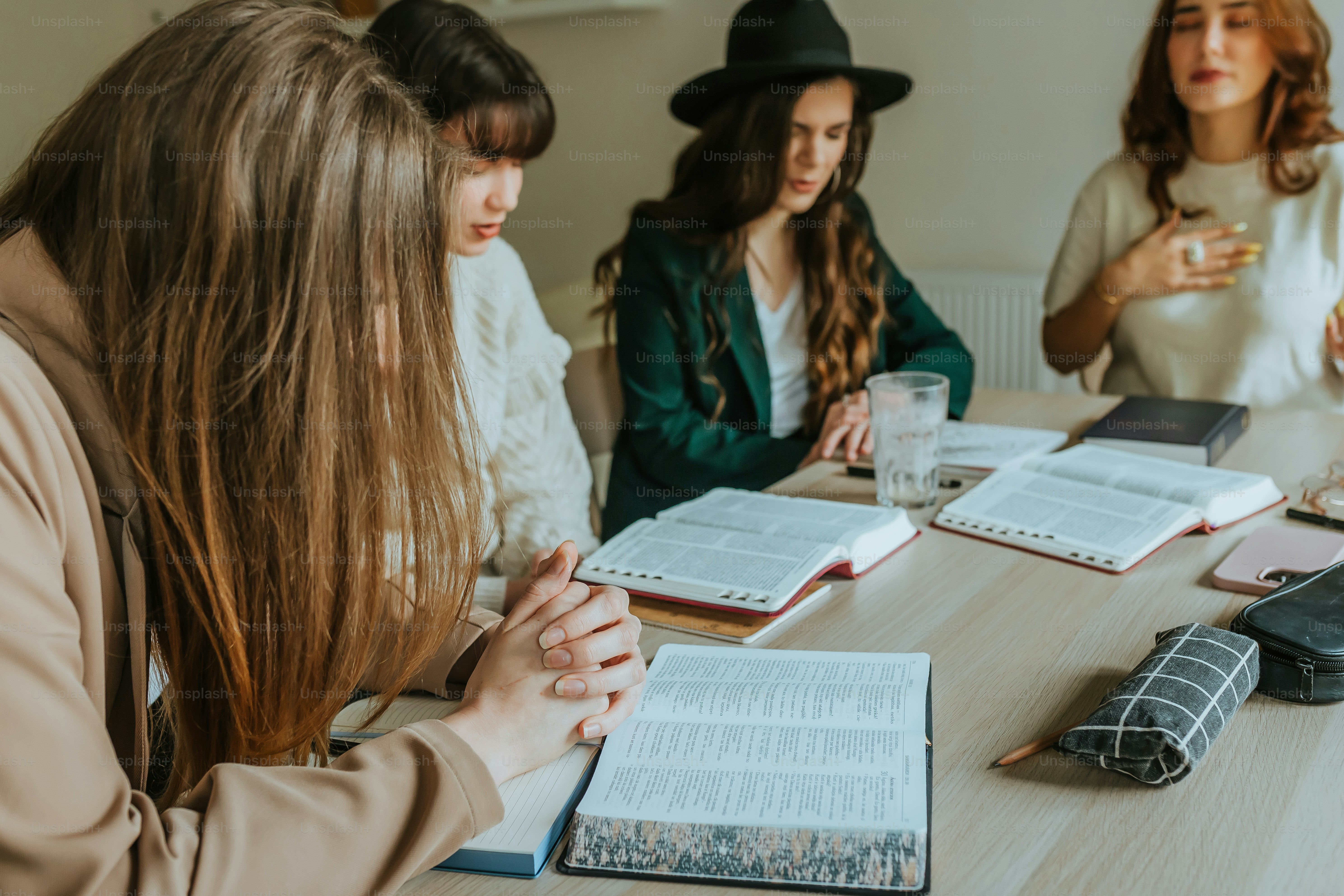 A group of women sitting around a wooden table photo – Youth group ...