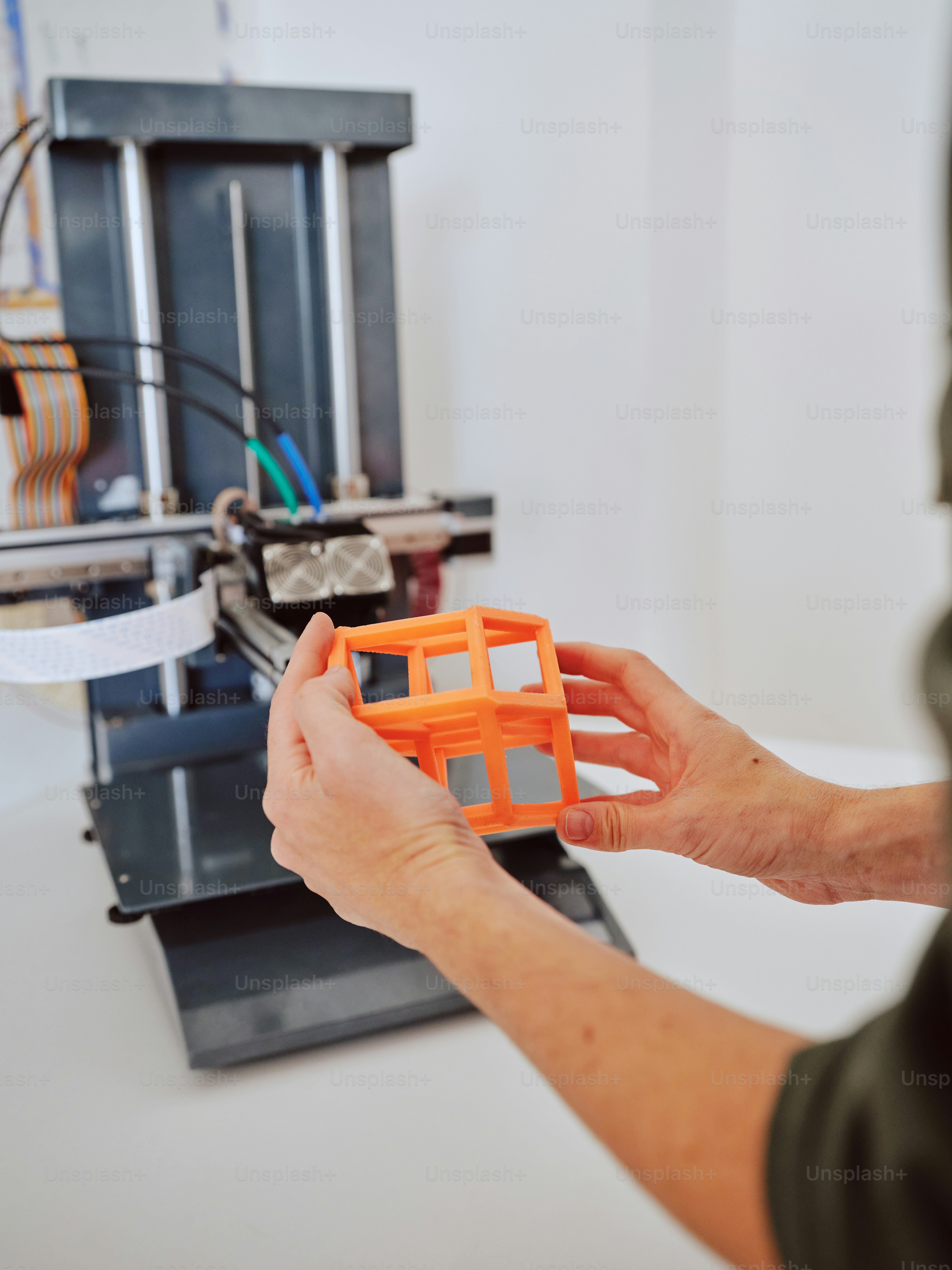 A person is working on a 3d printer photo – 3d printing studio Image on ...