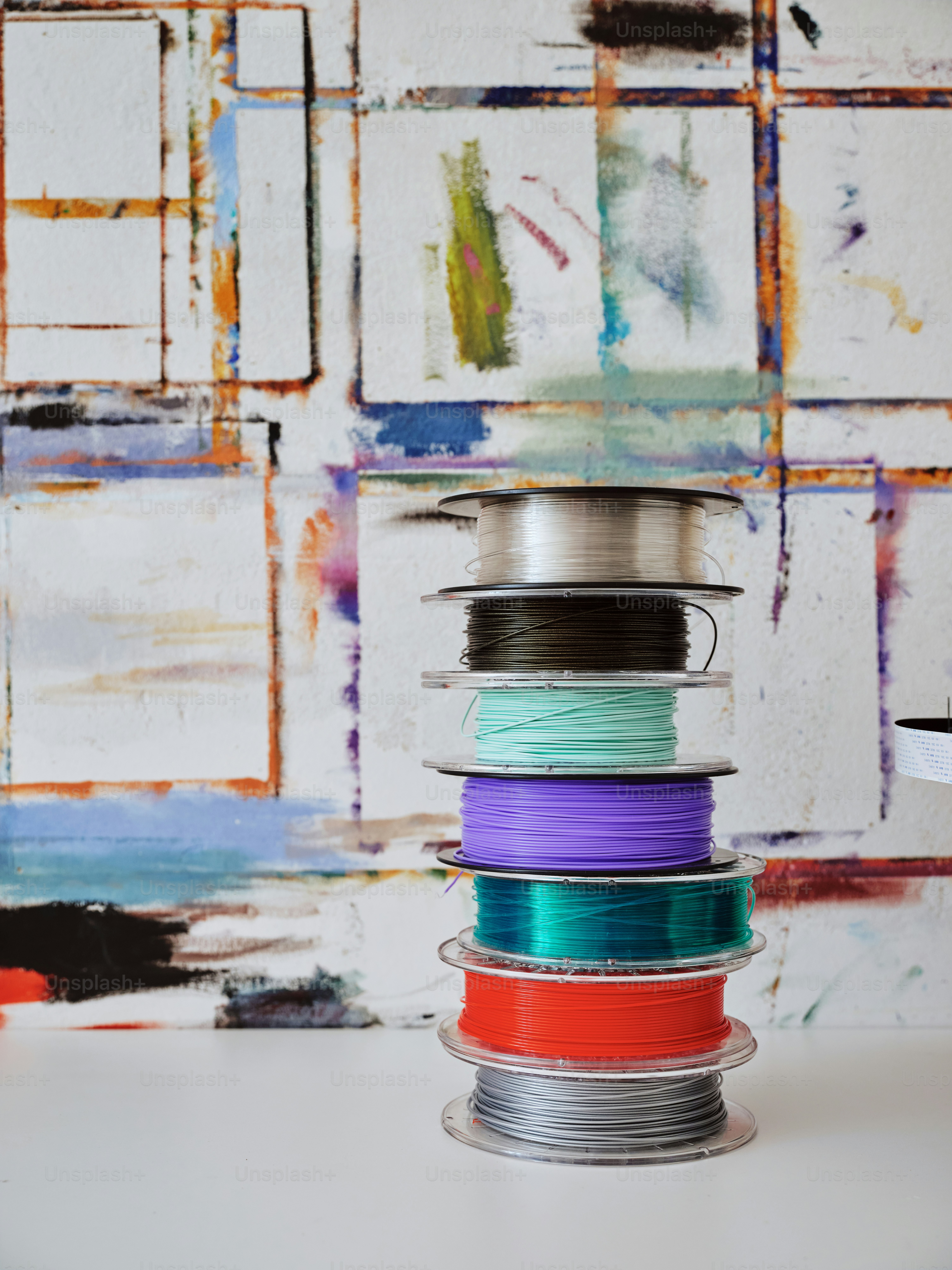 A spool of thread sitting on top of a white table photo – Technology ...