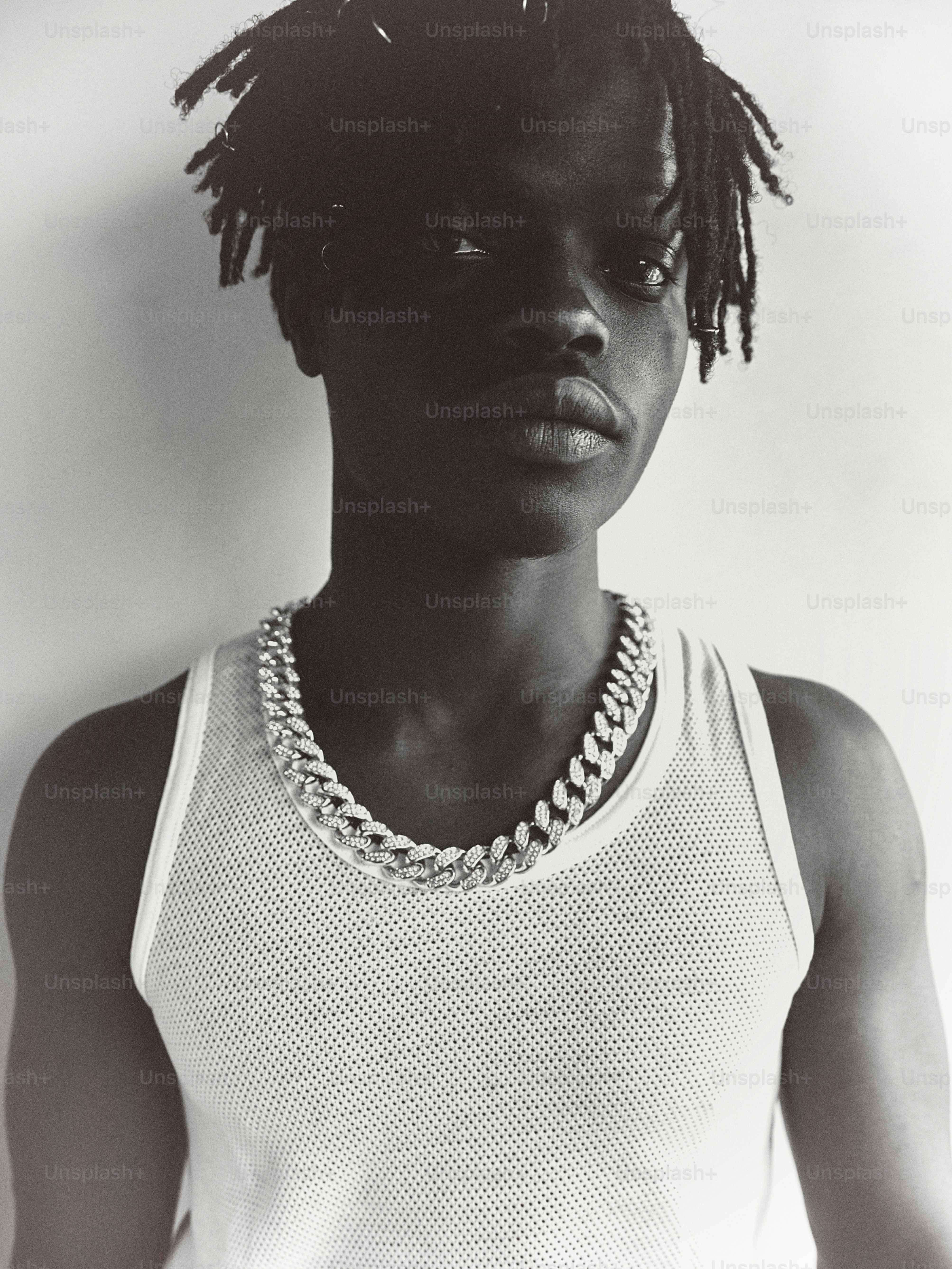 A black and white photo of a woman with dreadlocks photo – Gold chain ...
