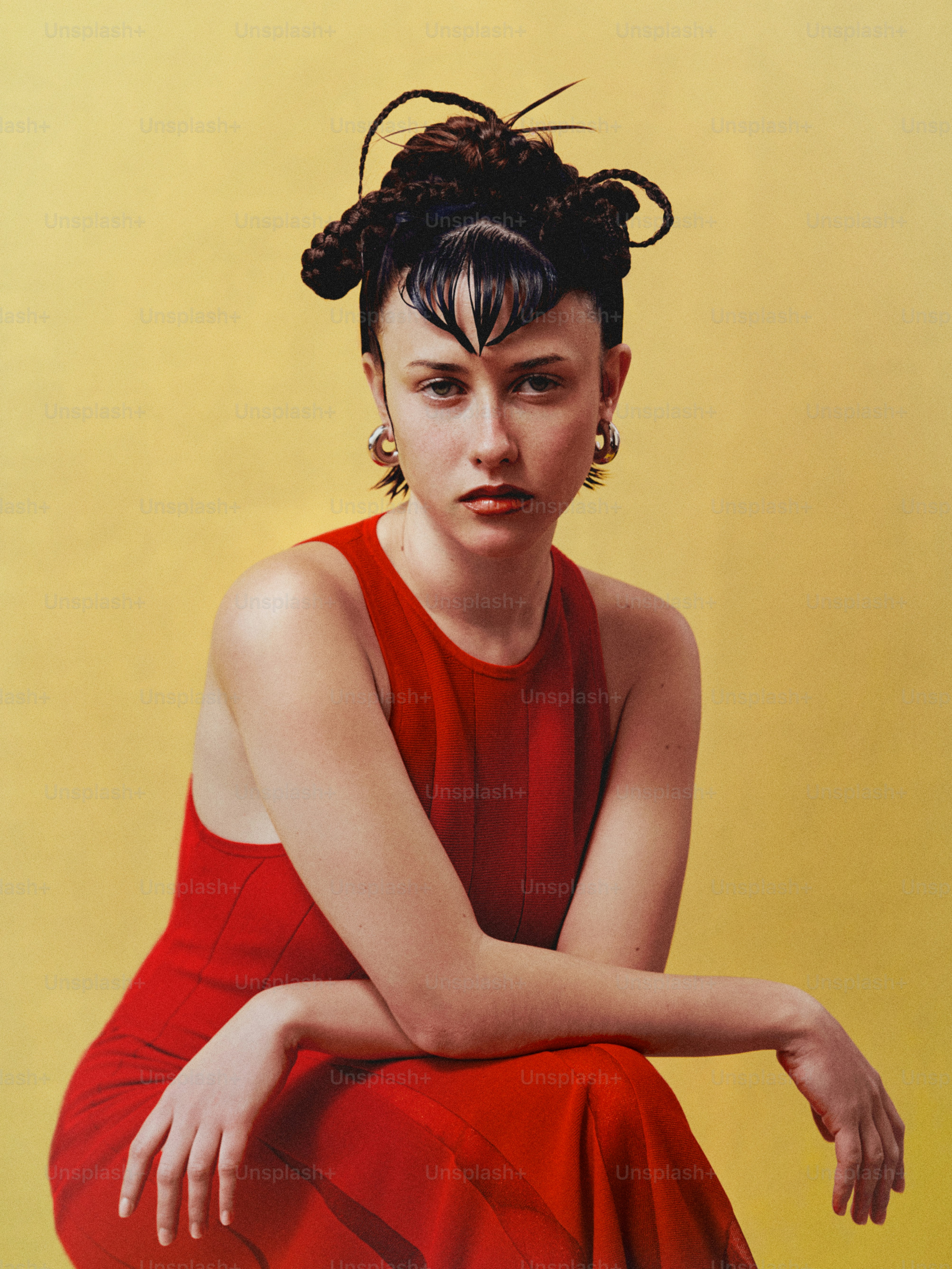 A woman in a red dress sitting on a stool photo – Gen z Image on Unsplash