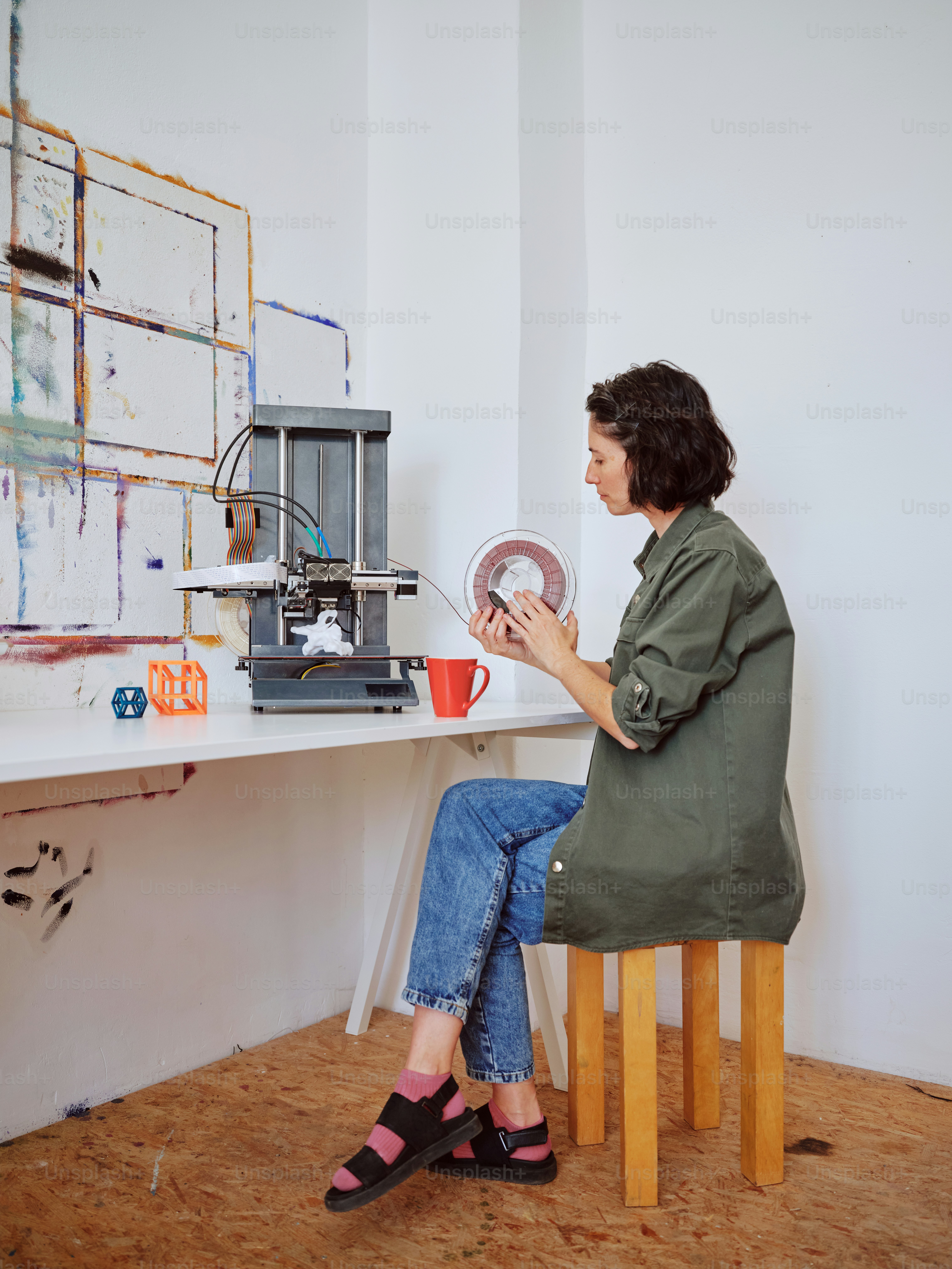 A woman sitting on a chair in front of a table photo – 3d designer ...