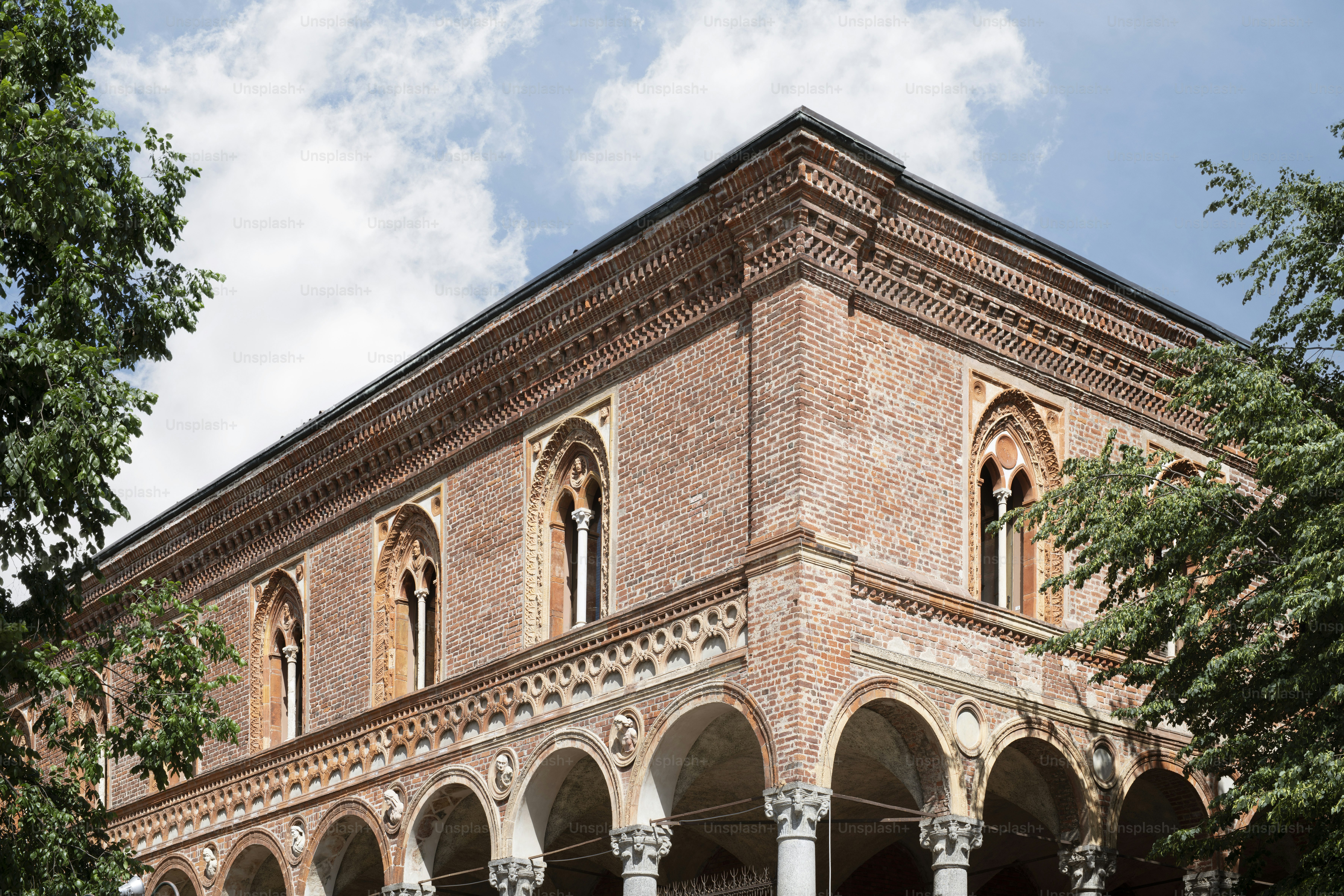 A large brick building with arches and arches around it photo – Art ...