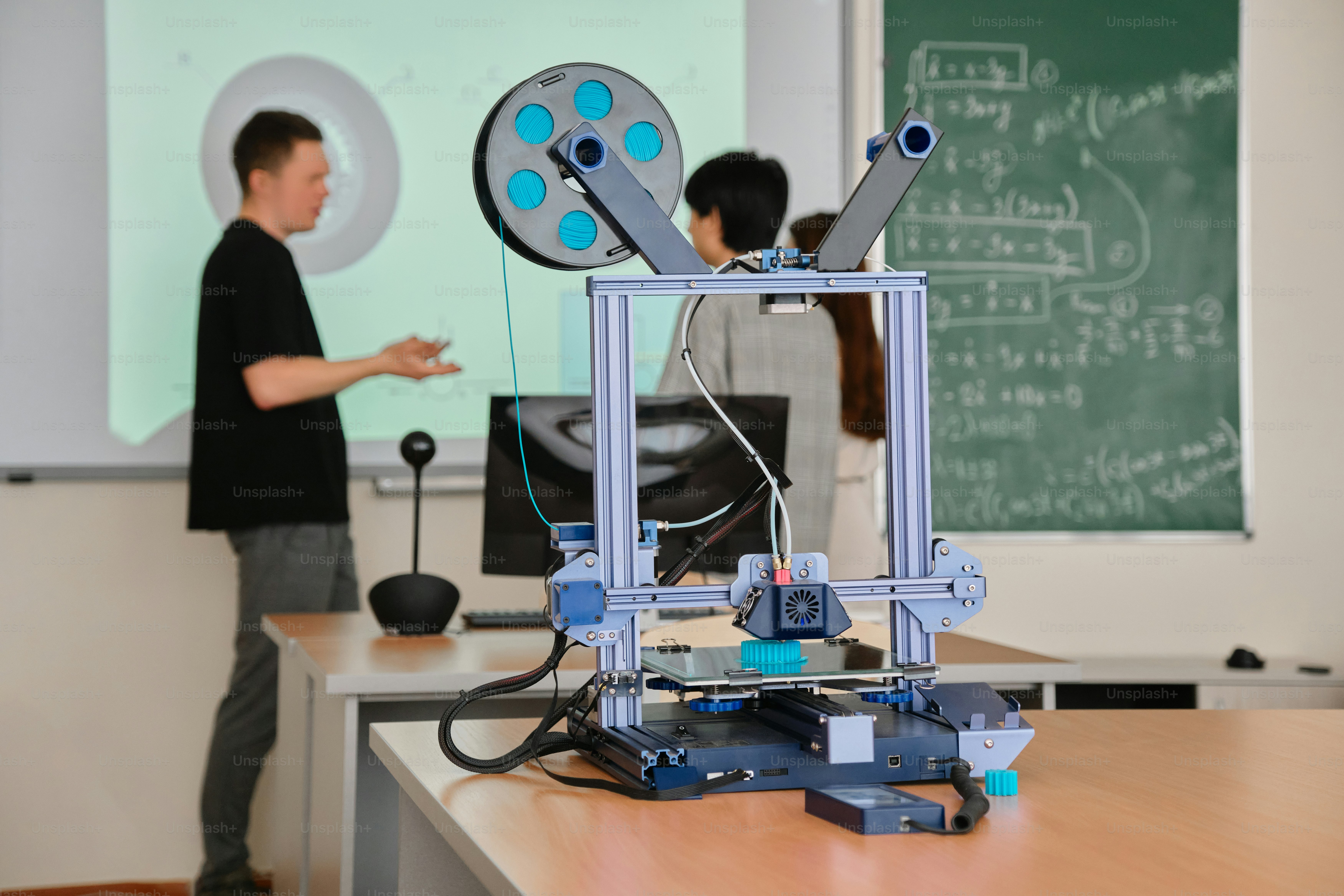 A man standing in front of a projector in a classroom photo – 3d ...