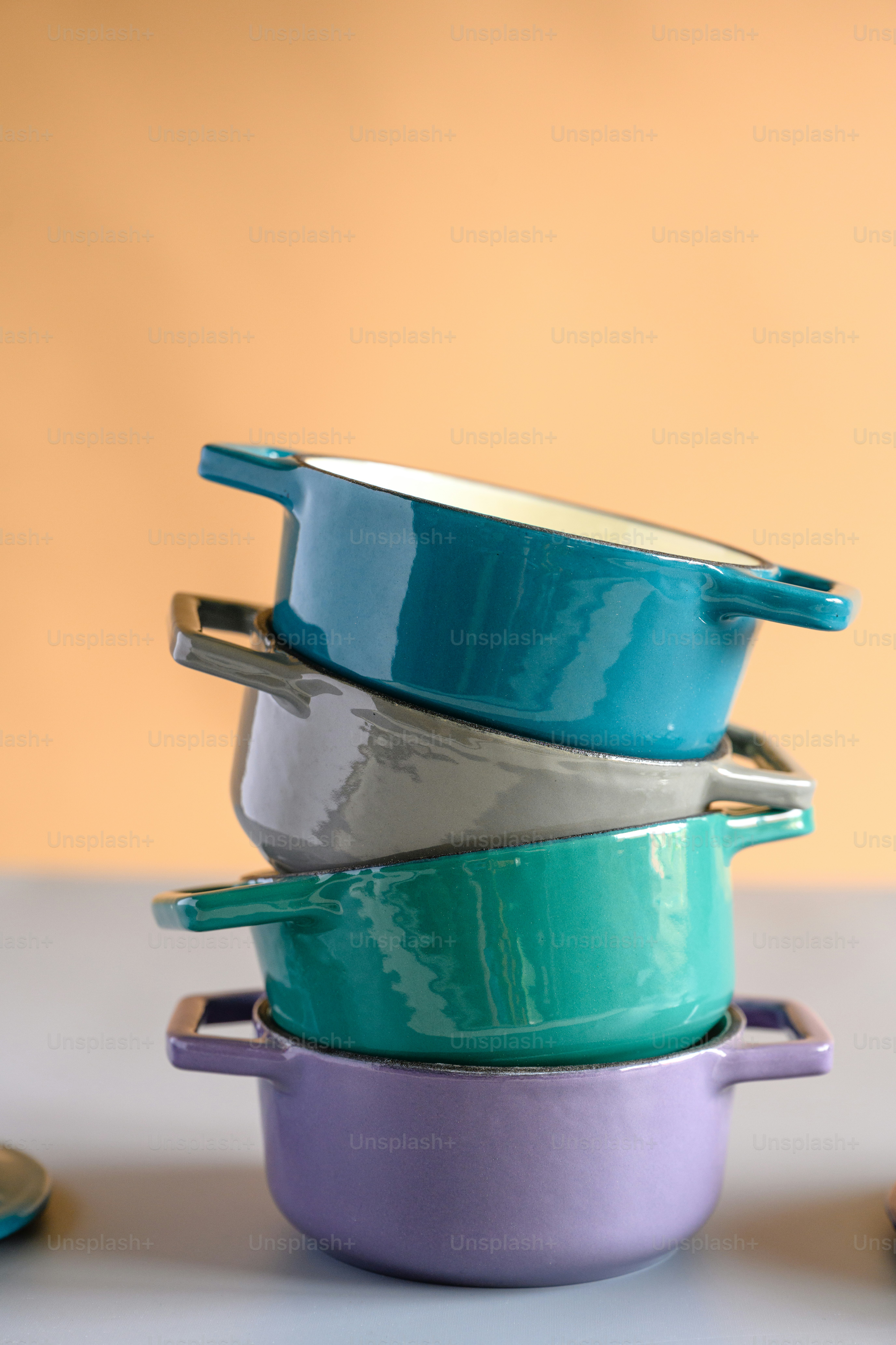 A stack of pots sitting on top of a table photo – Casserole Image on ...