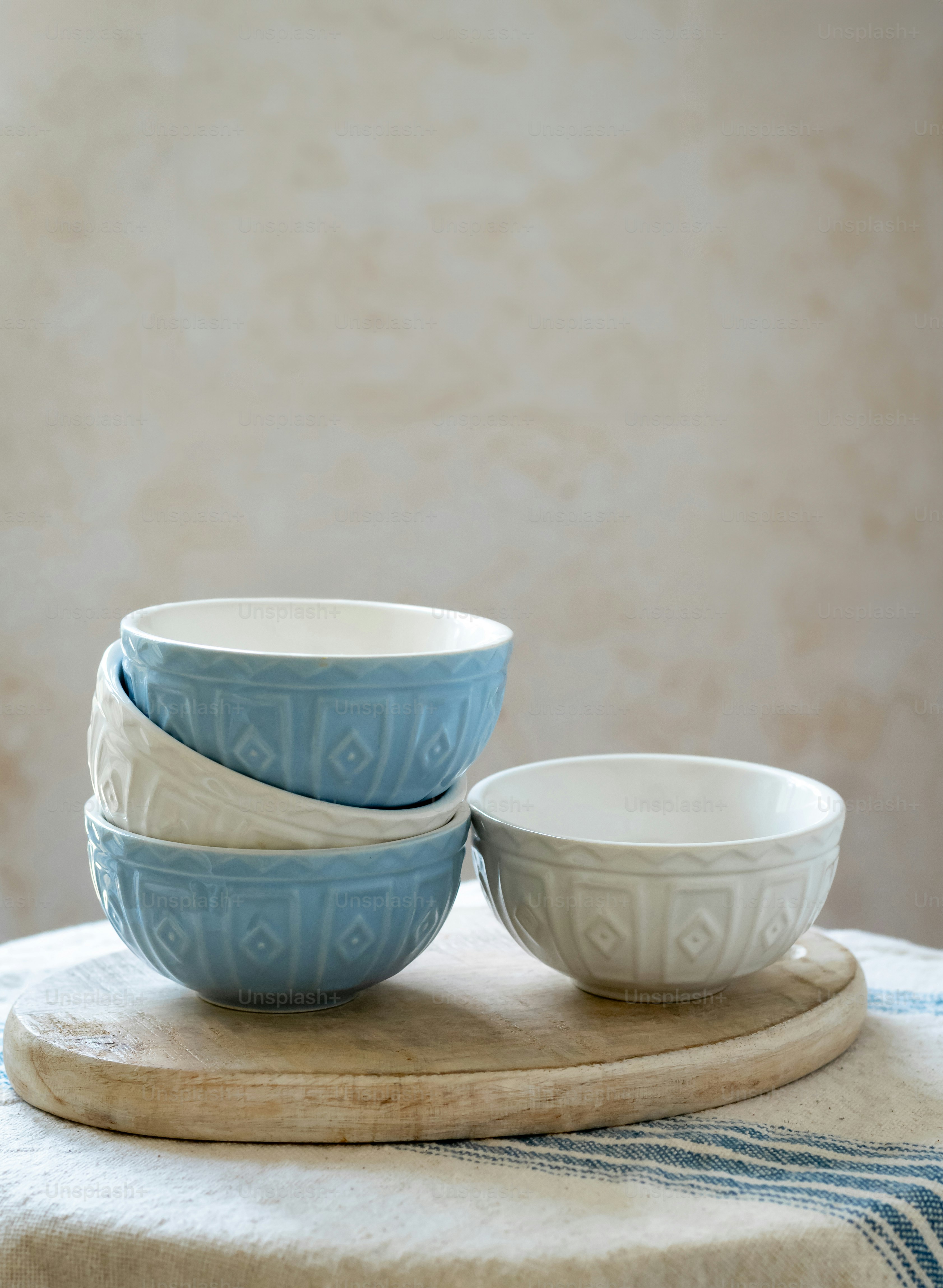A couple of bowls sitting on top of a table photo – Stack of bowls ...