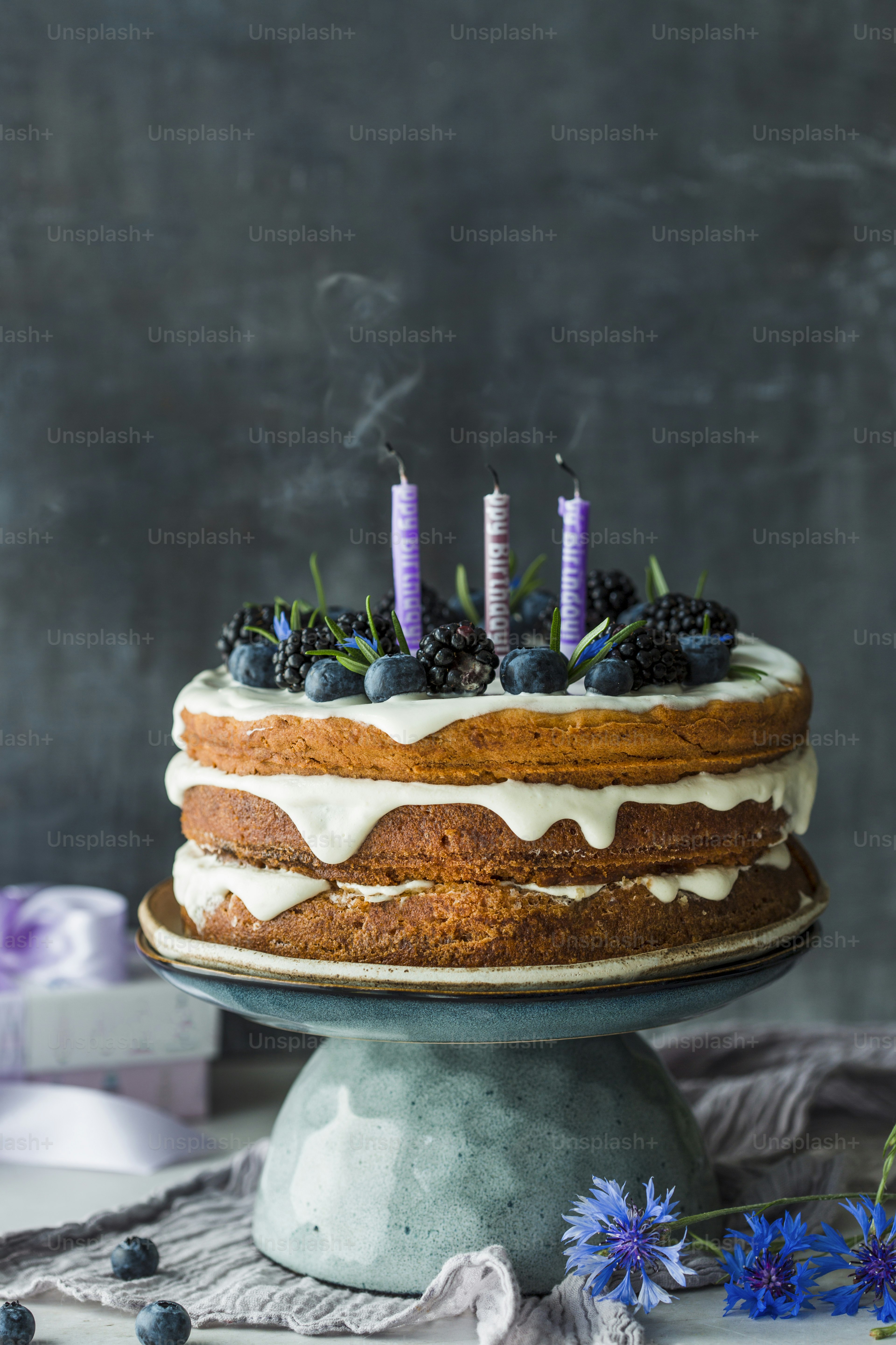 A cake with blueberries and candles on top of it photo – Cakes Image on ...